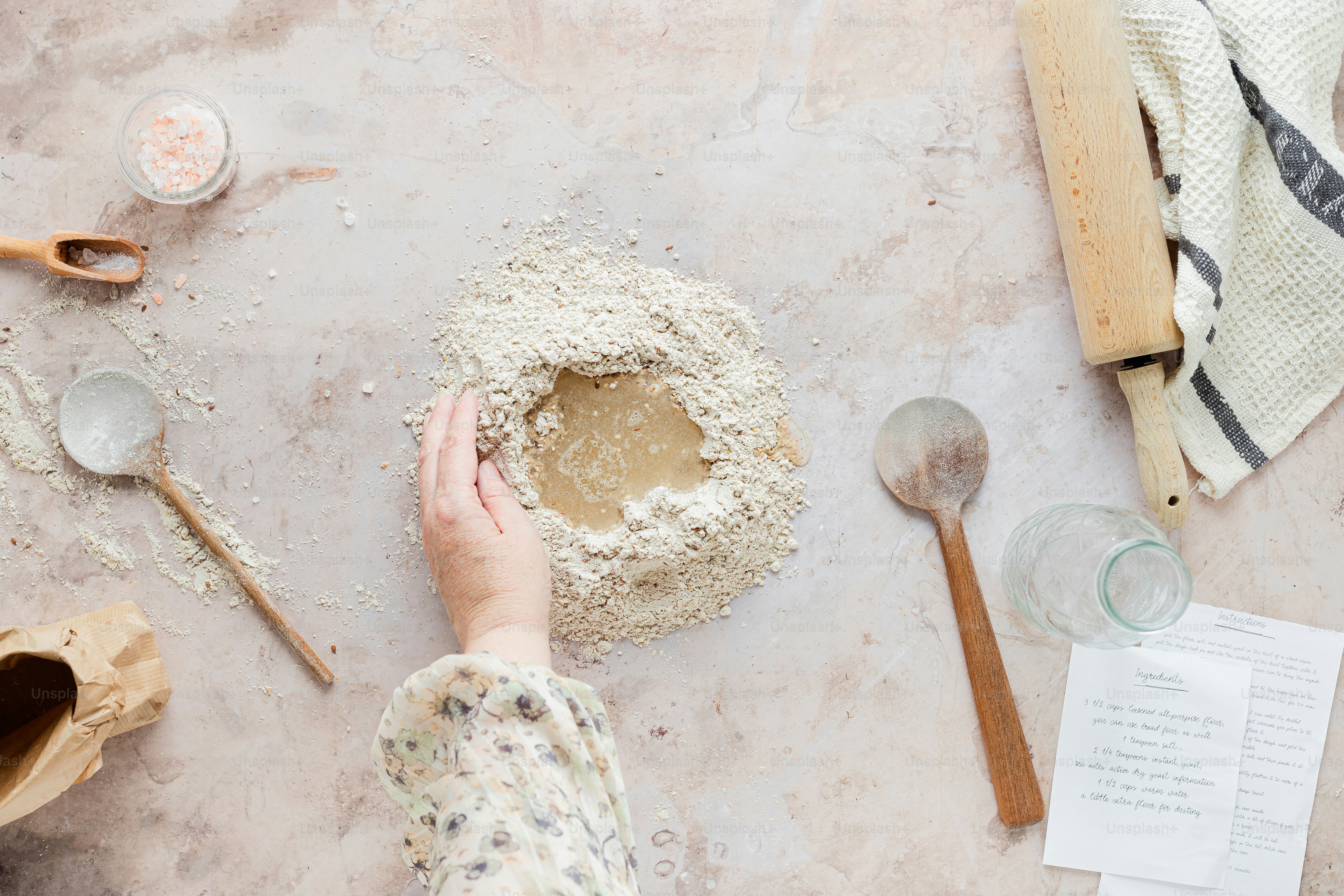 A person is making a doughnut on a table photo – Ingredients Image on ...