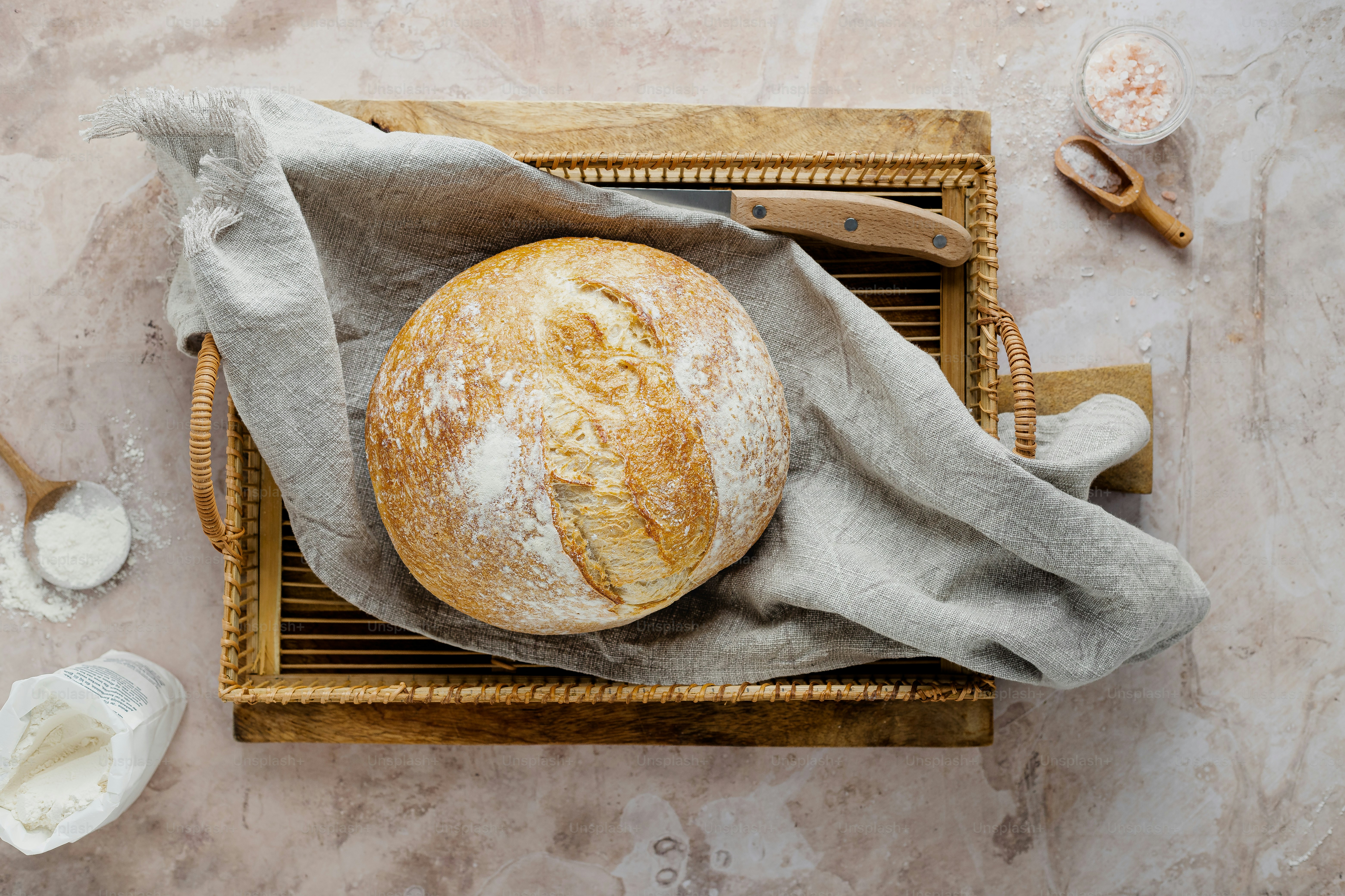 A loaf of bread sitting on top of a wooden tray photo – Bread Image on ...