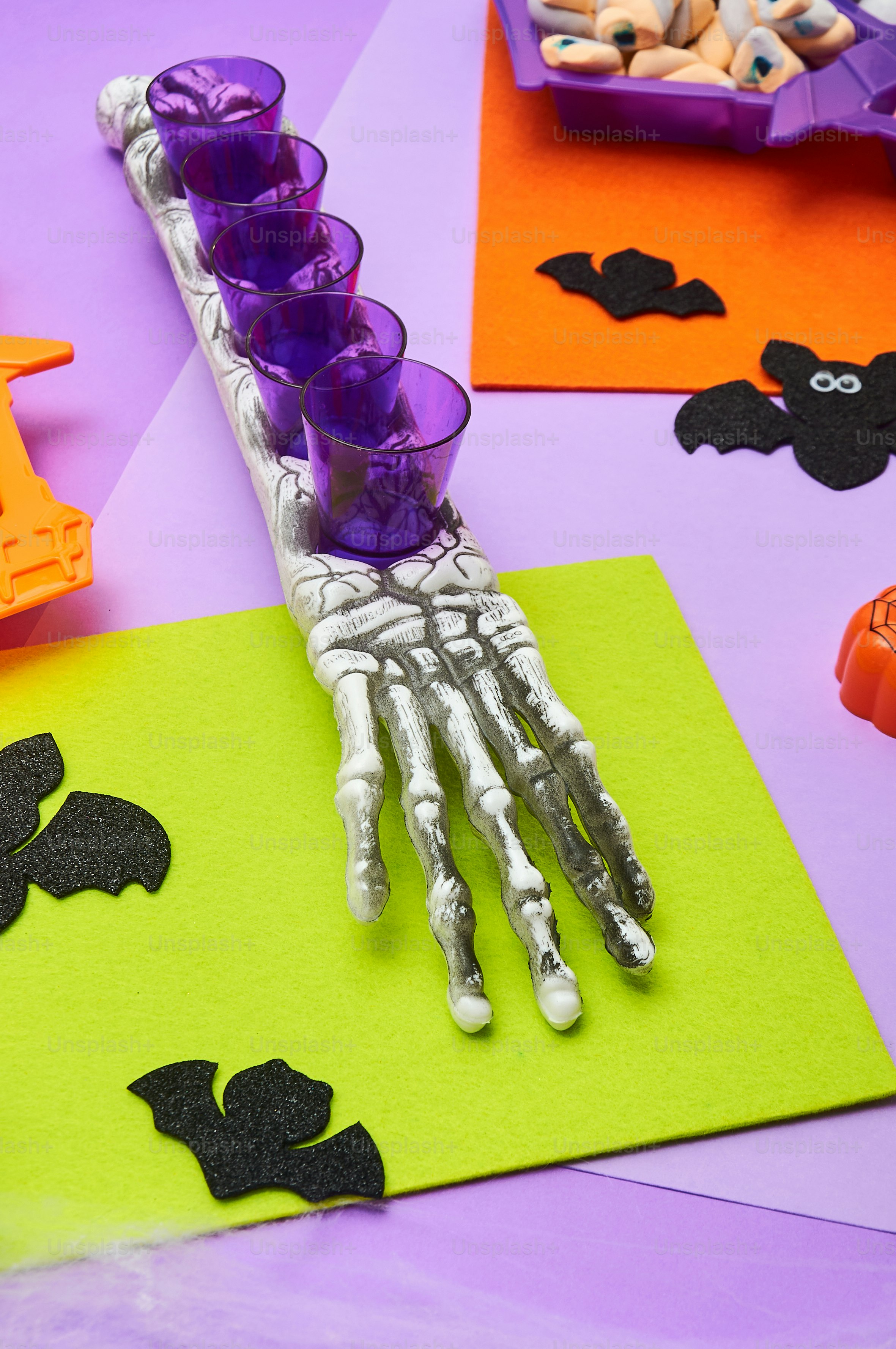 A table with halloween decorations and a skeleton hand photo – Skeleton ...