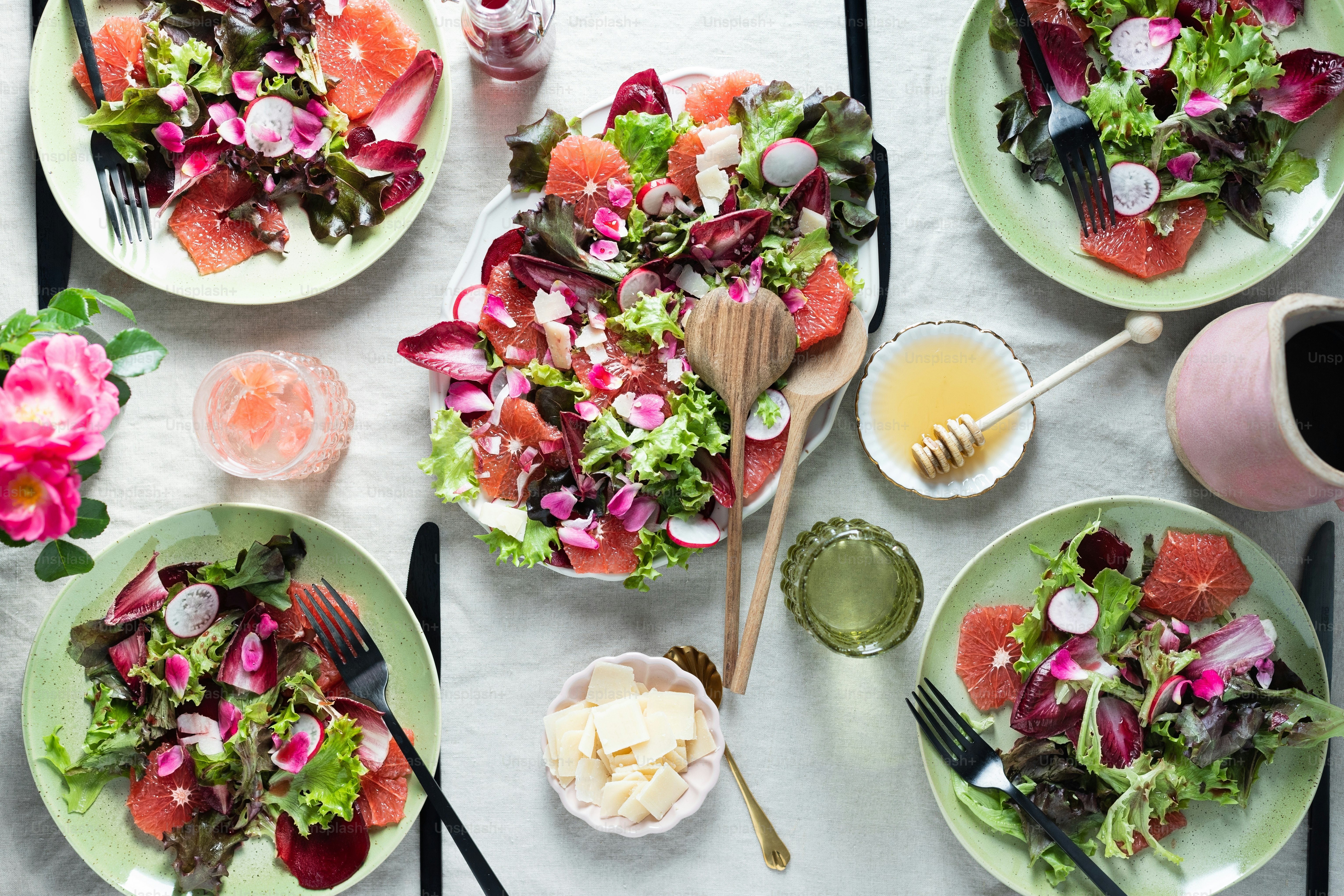 A table topped with plates of food and drinks photo – Salad Image on ...