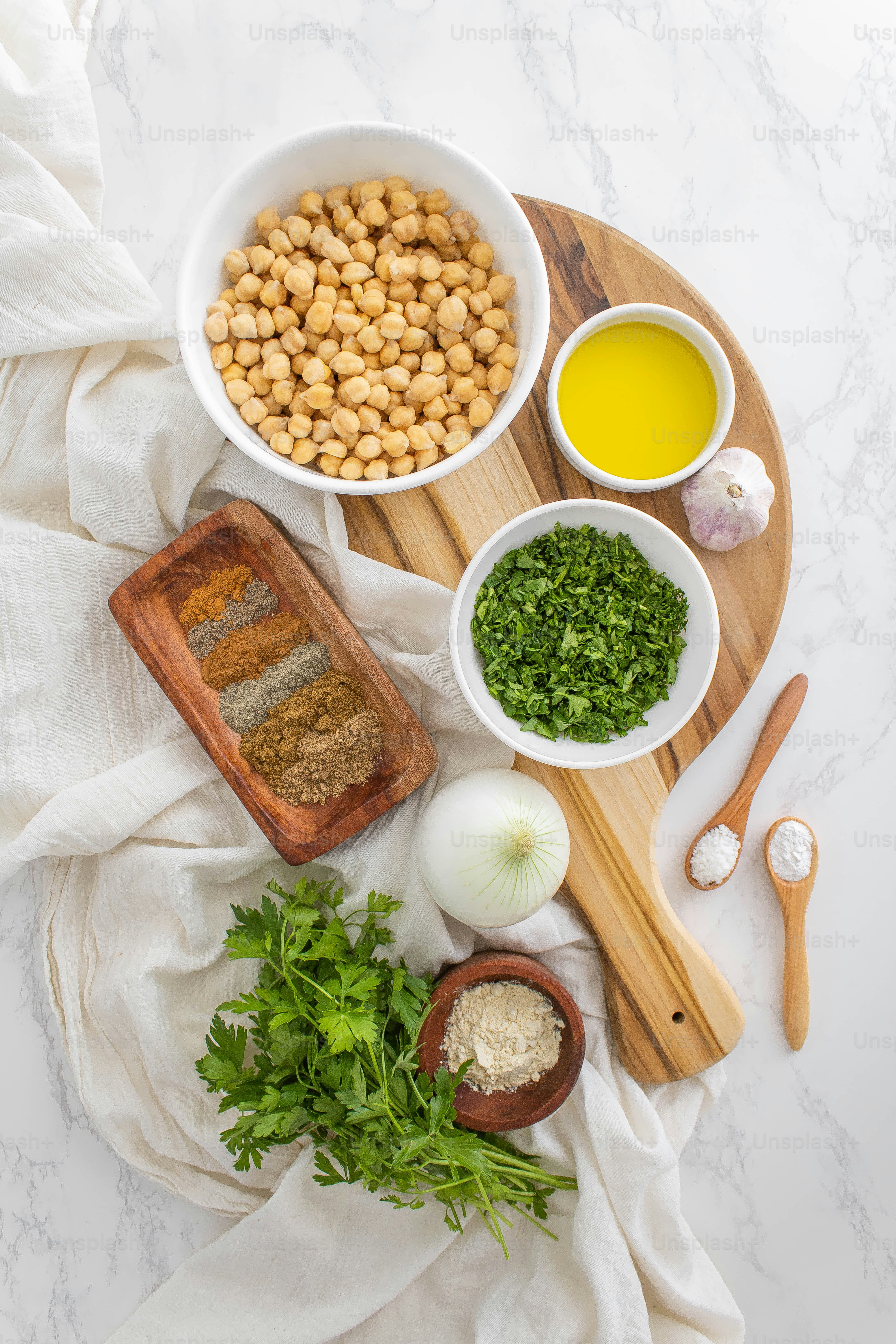 A table topped with bowls of food next to a cutting board photo – Food ...