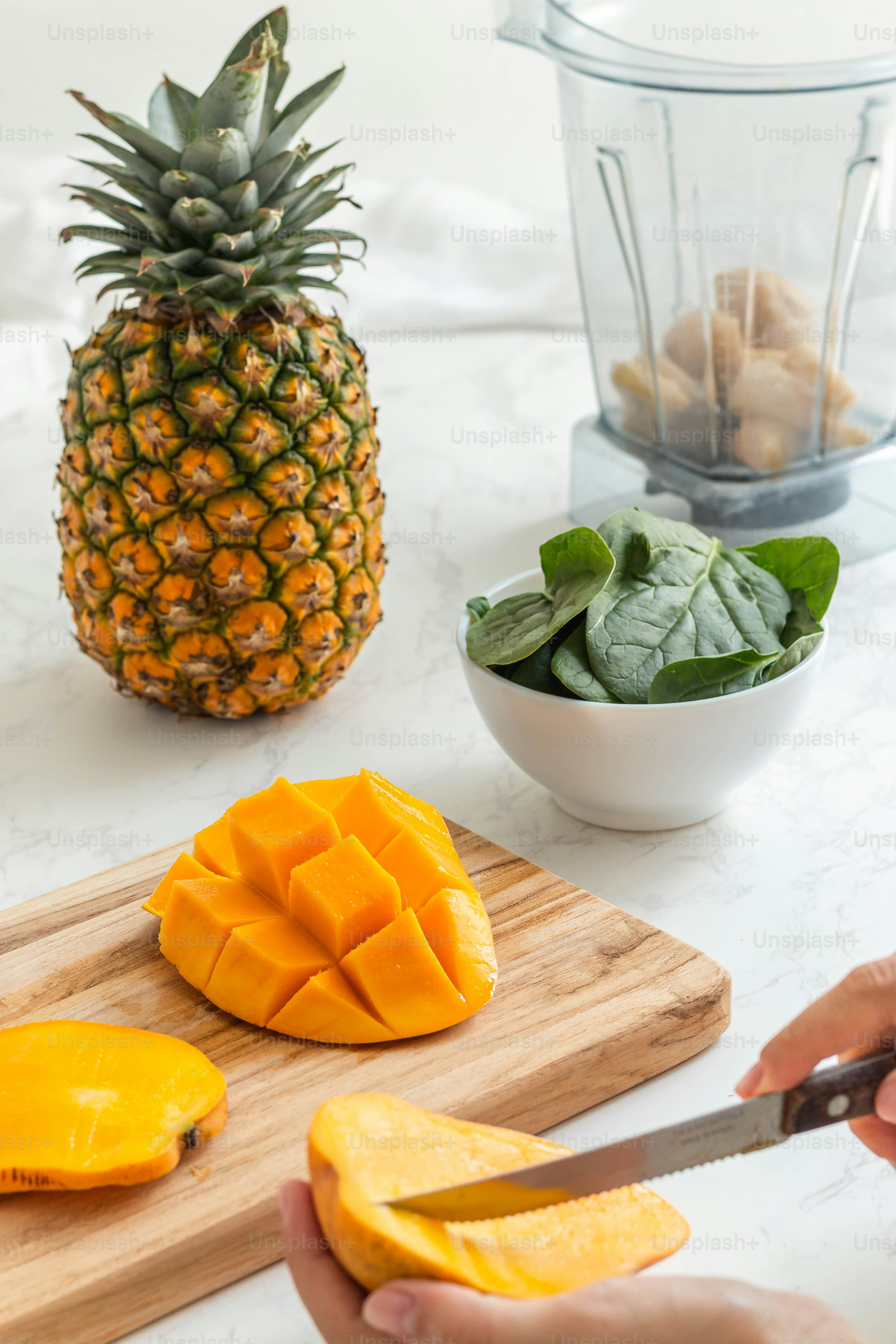 A person cutting up a mango on a cutting board photo – Food Image on ...