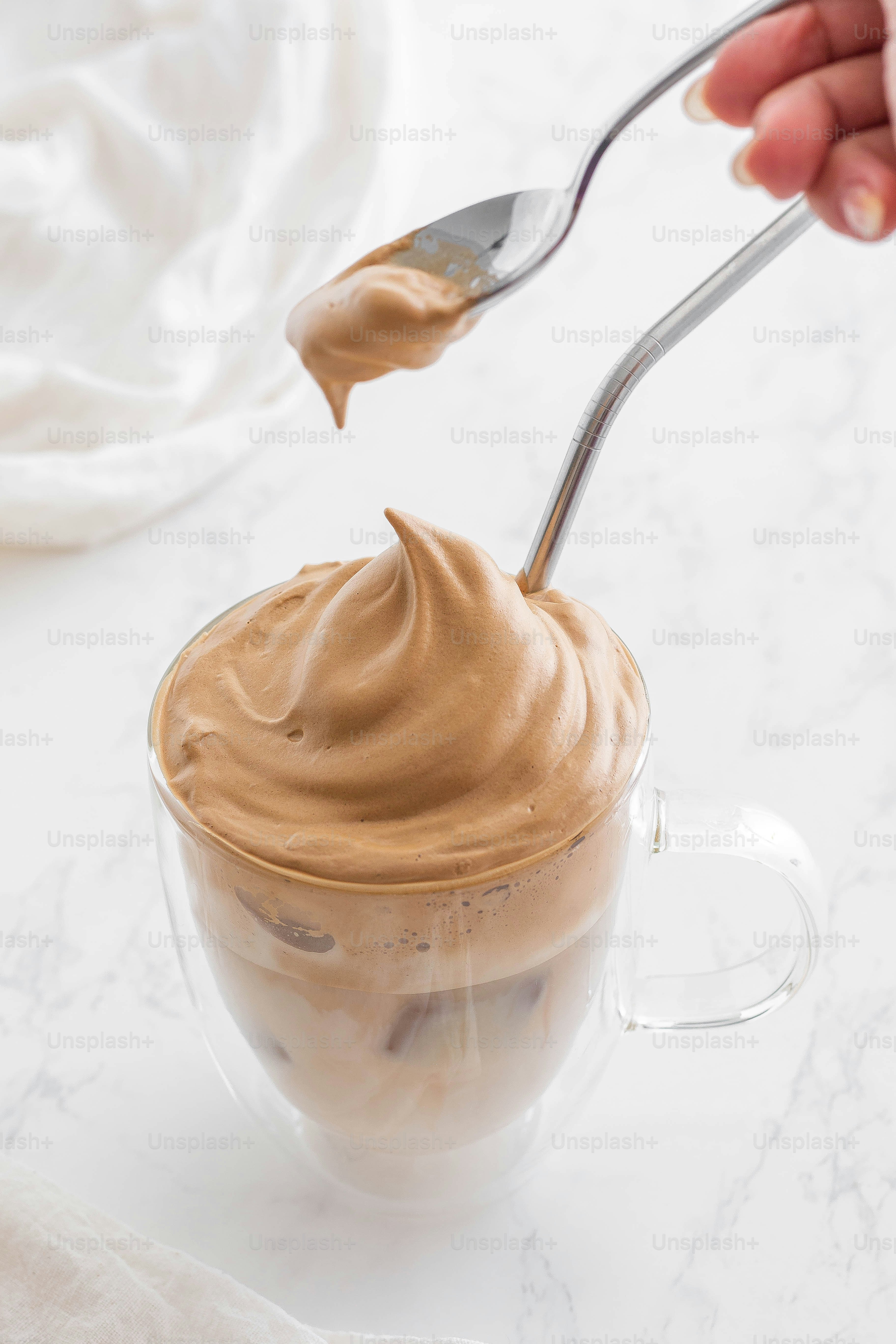 A person holding a spoon over a cup of chocolate pudding photo – Mousse ...
