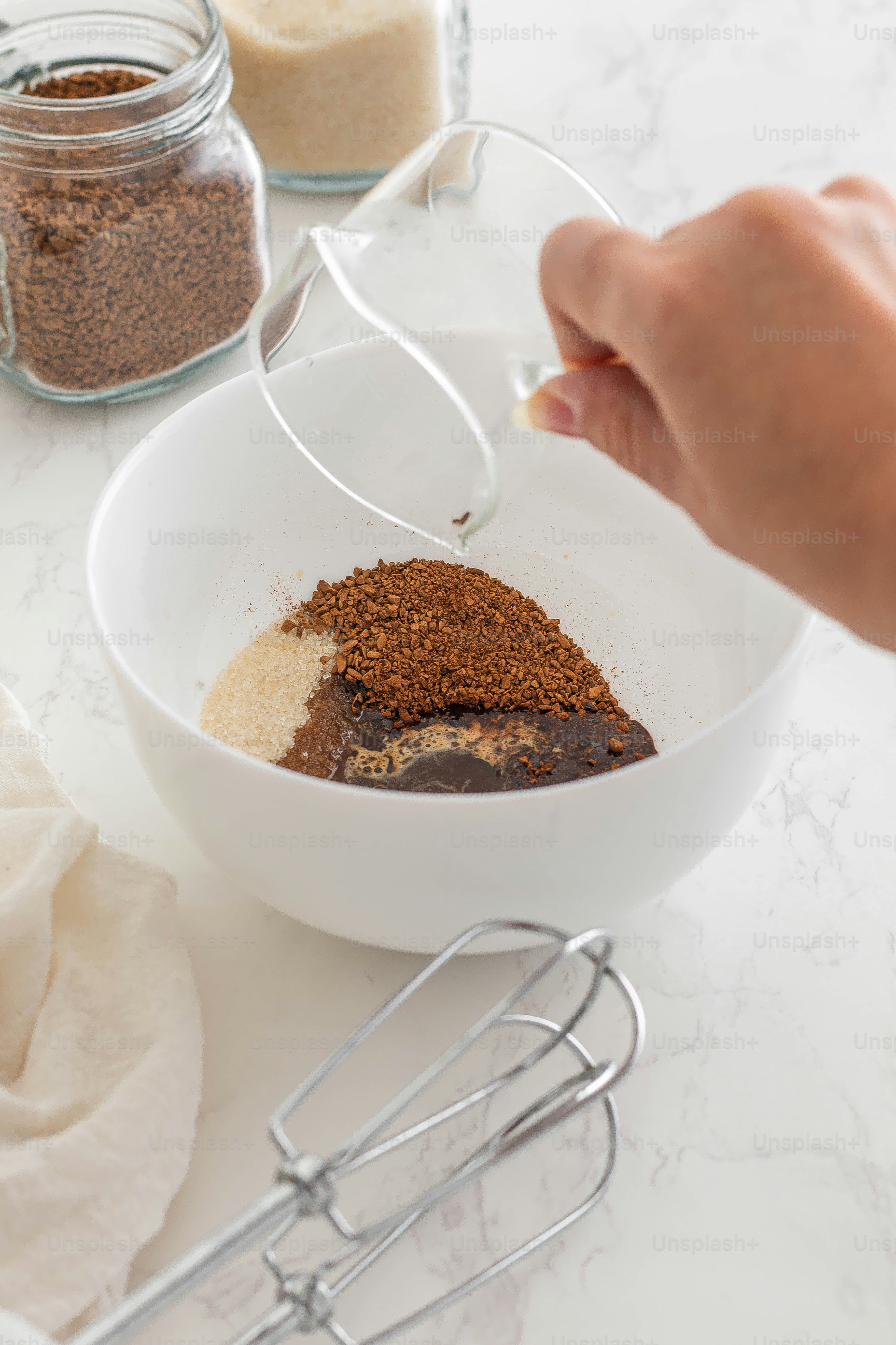 A person mixing ingredients in a bowl with a whisk photo – Food Image ...