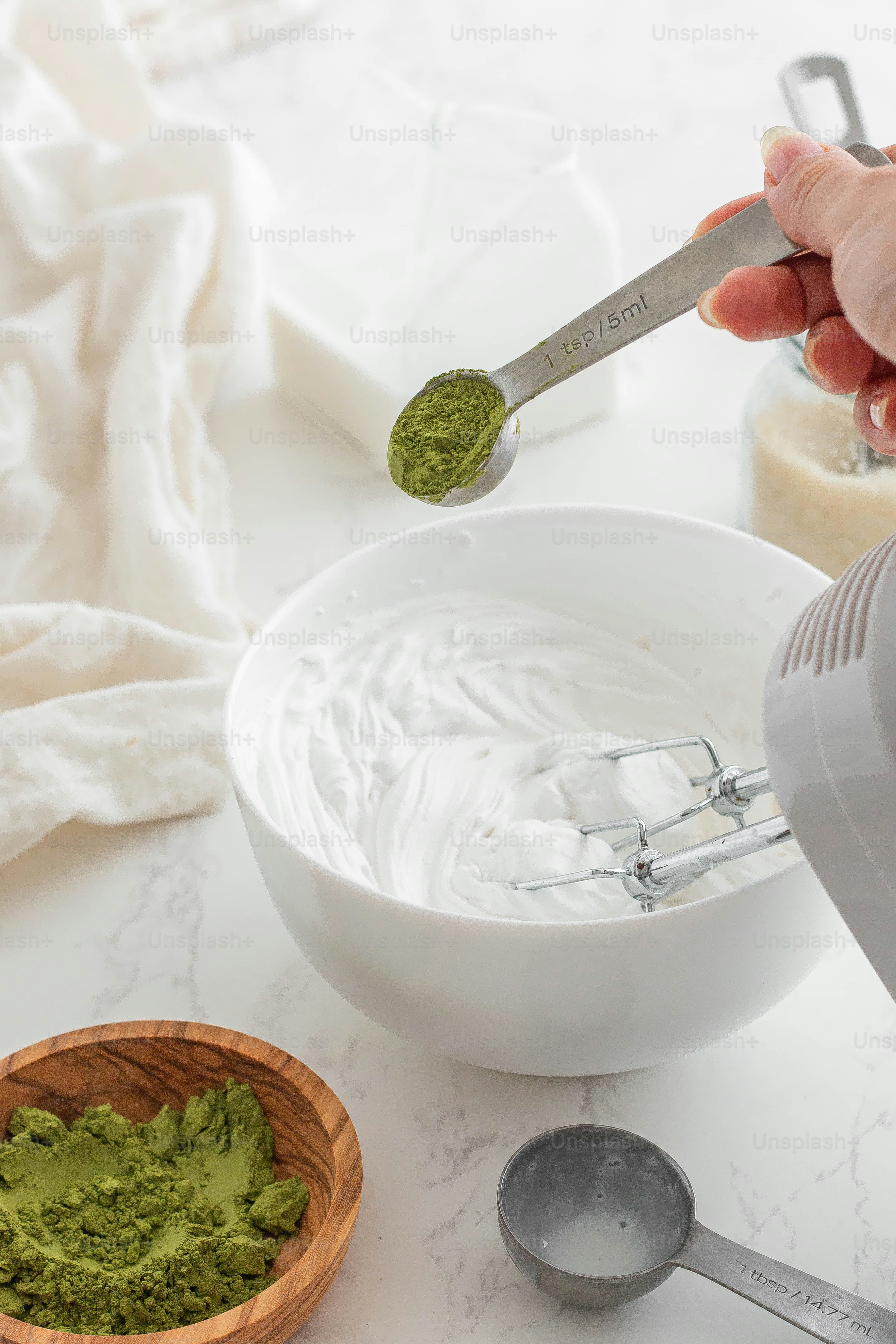 A person mixing a mixture in a white bowl photo – Healthy drink Image ...