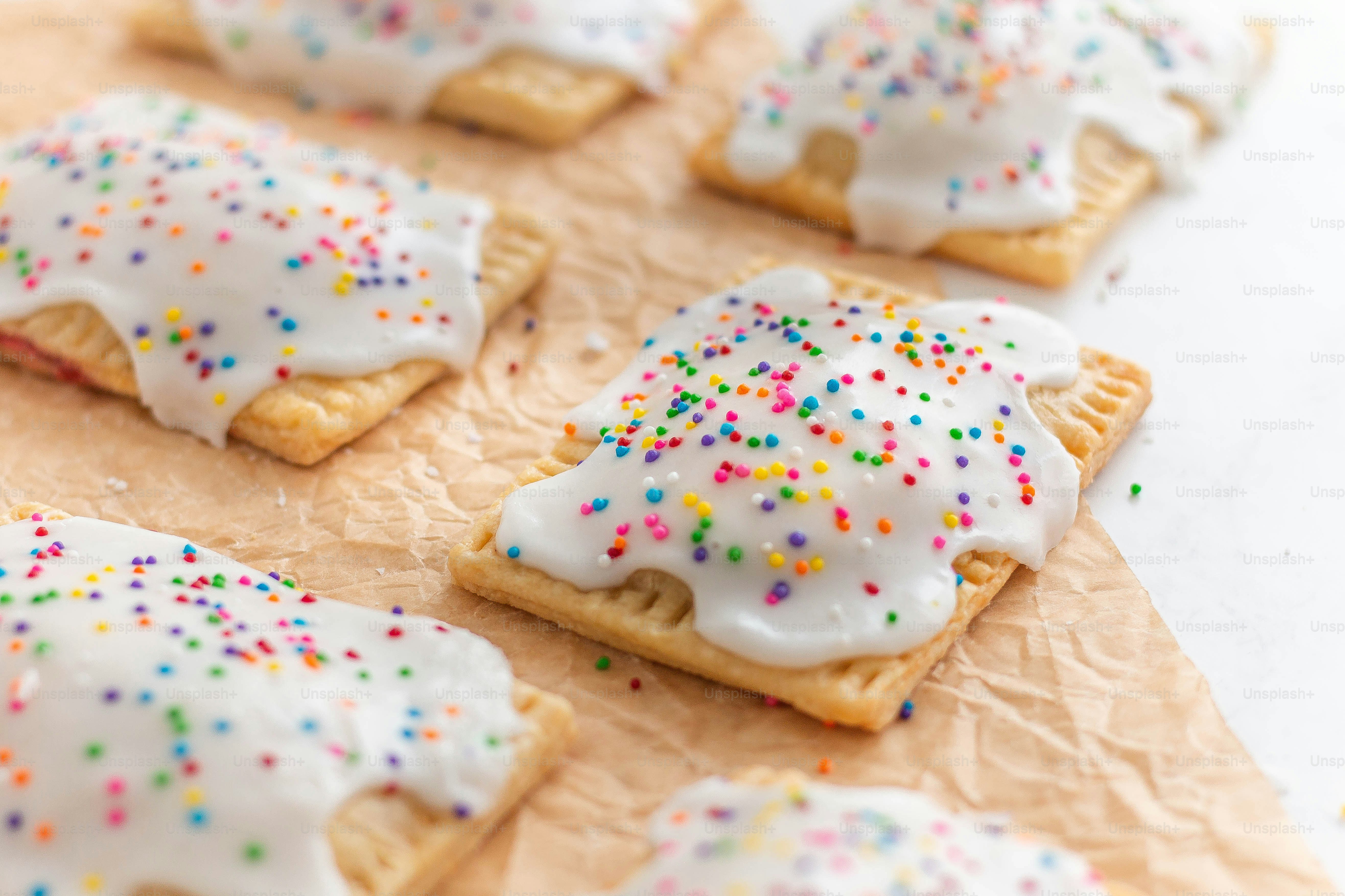 A table topped with lots of white frosting and sprinkles photo ...