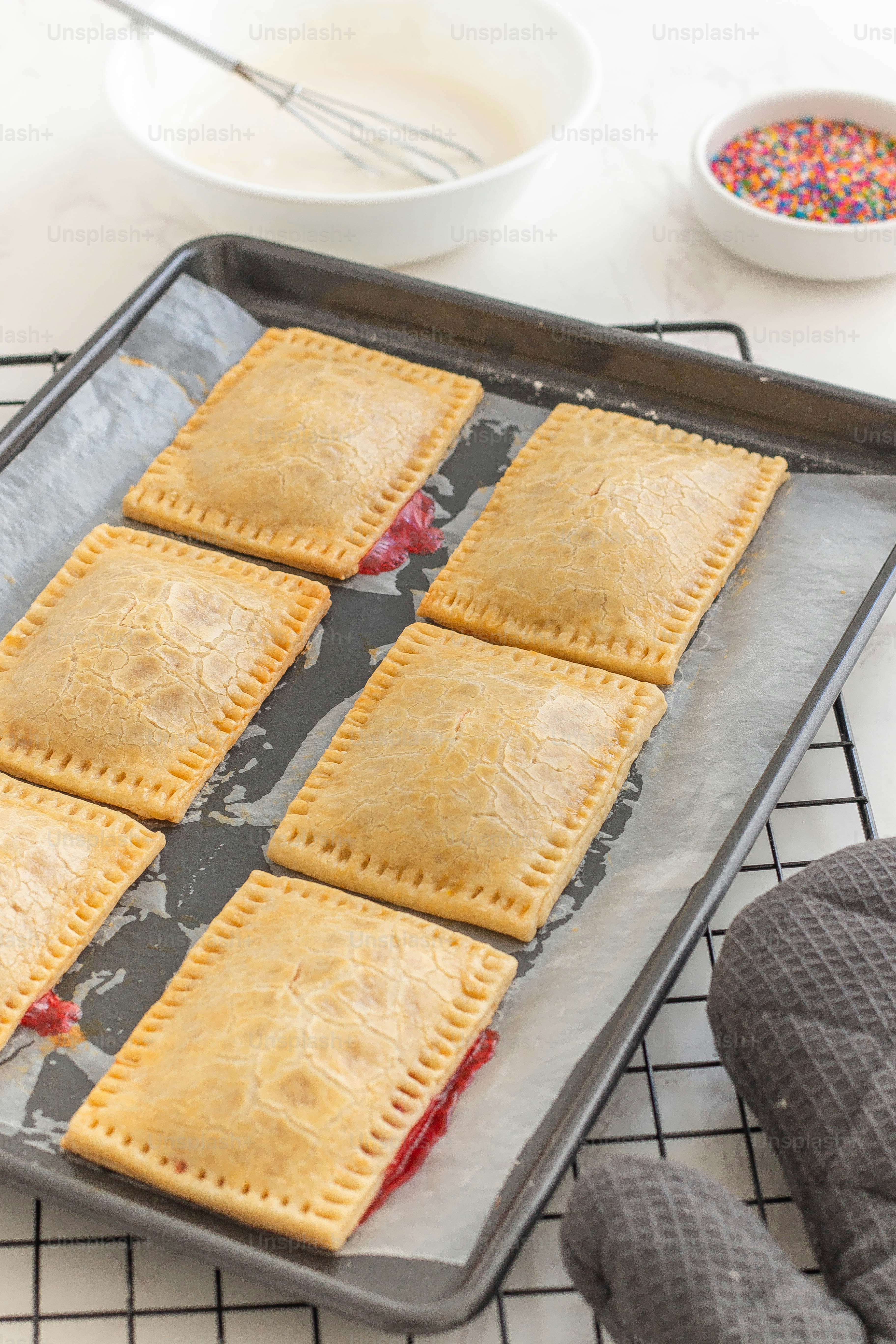A tray of pastries sitting on top of a table photo – Homemade dessert ...