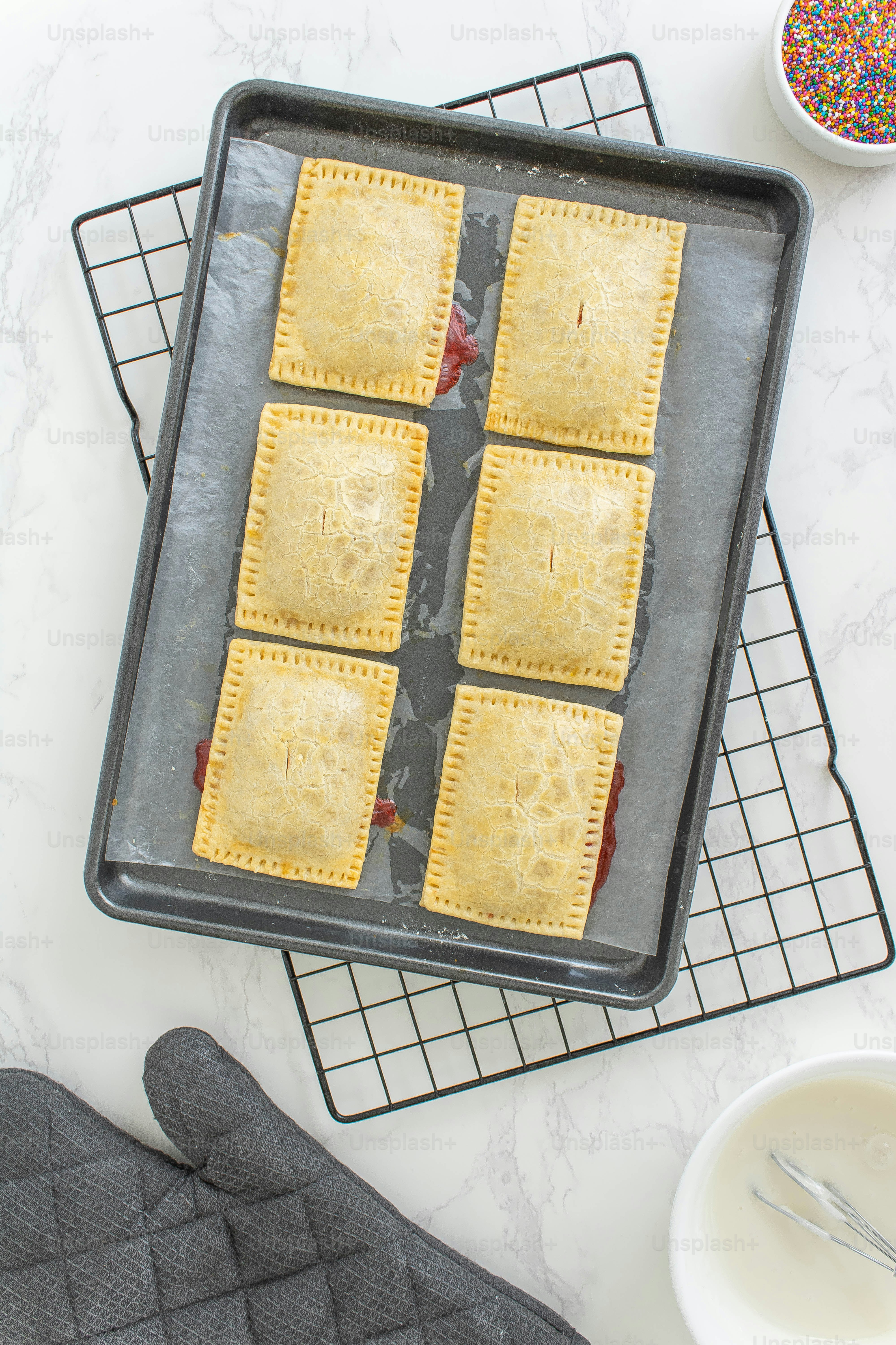 A tray of pastries sitting on top of a cooling rack photo – Food Image ...