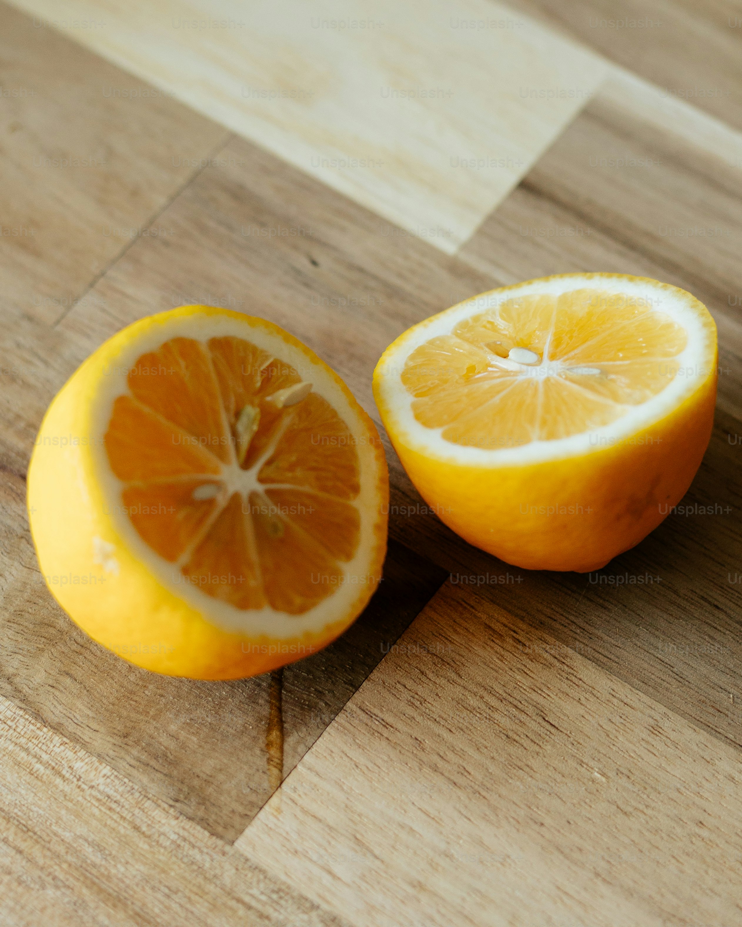 Two oranges cut in half on a cutting board photo – Healthy food Image ...