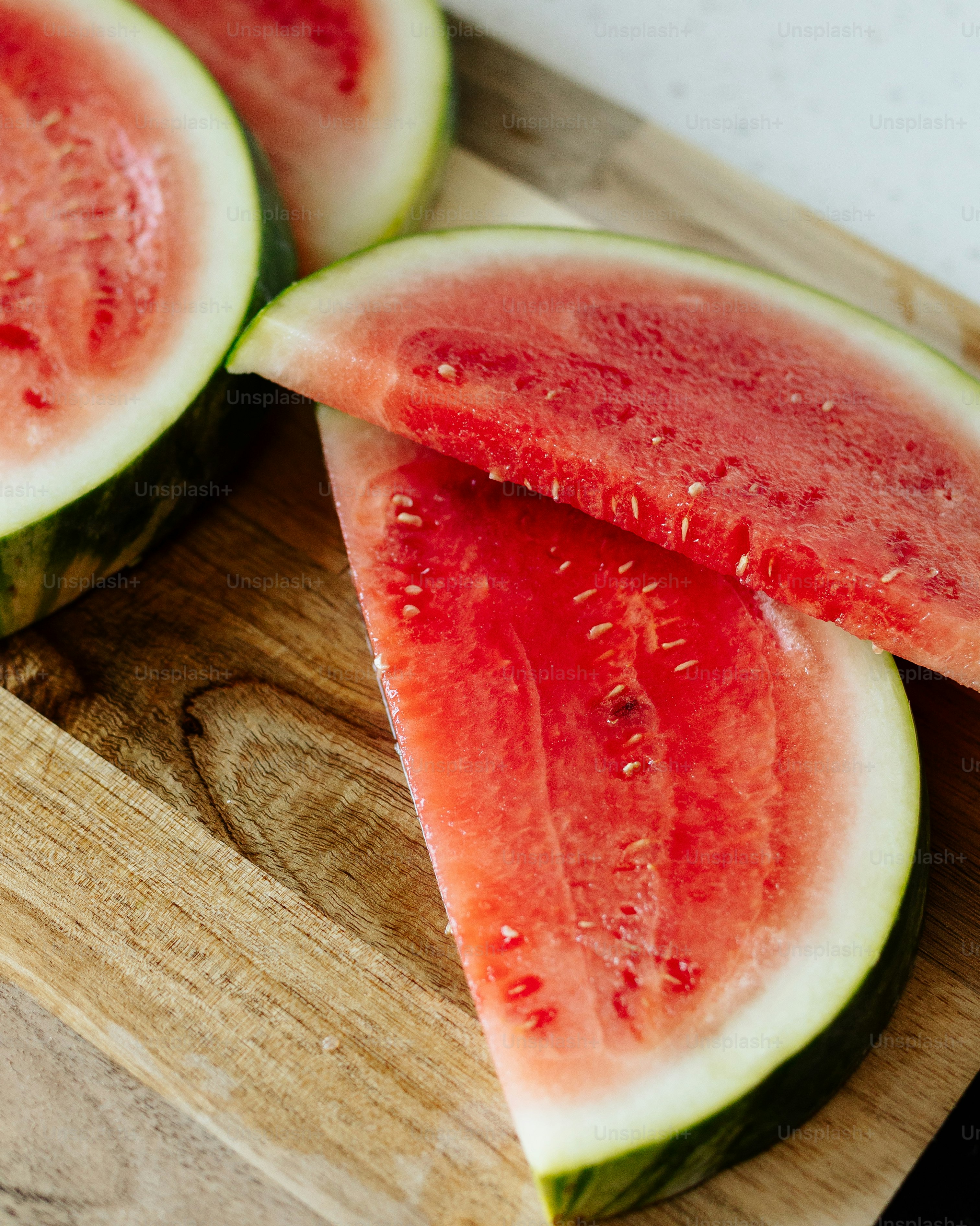 Slices of watermelon sitting on a cutting board photo – Food Image on ...