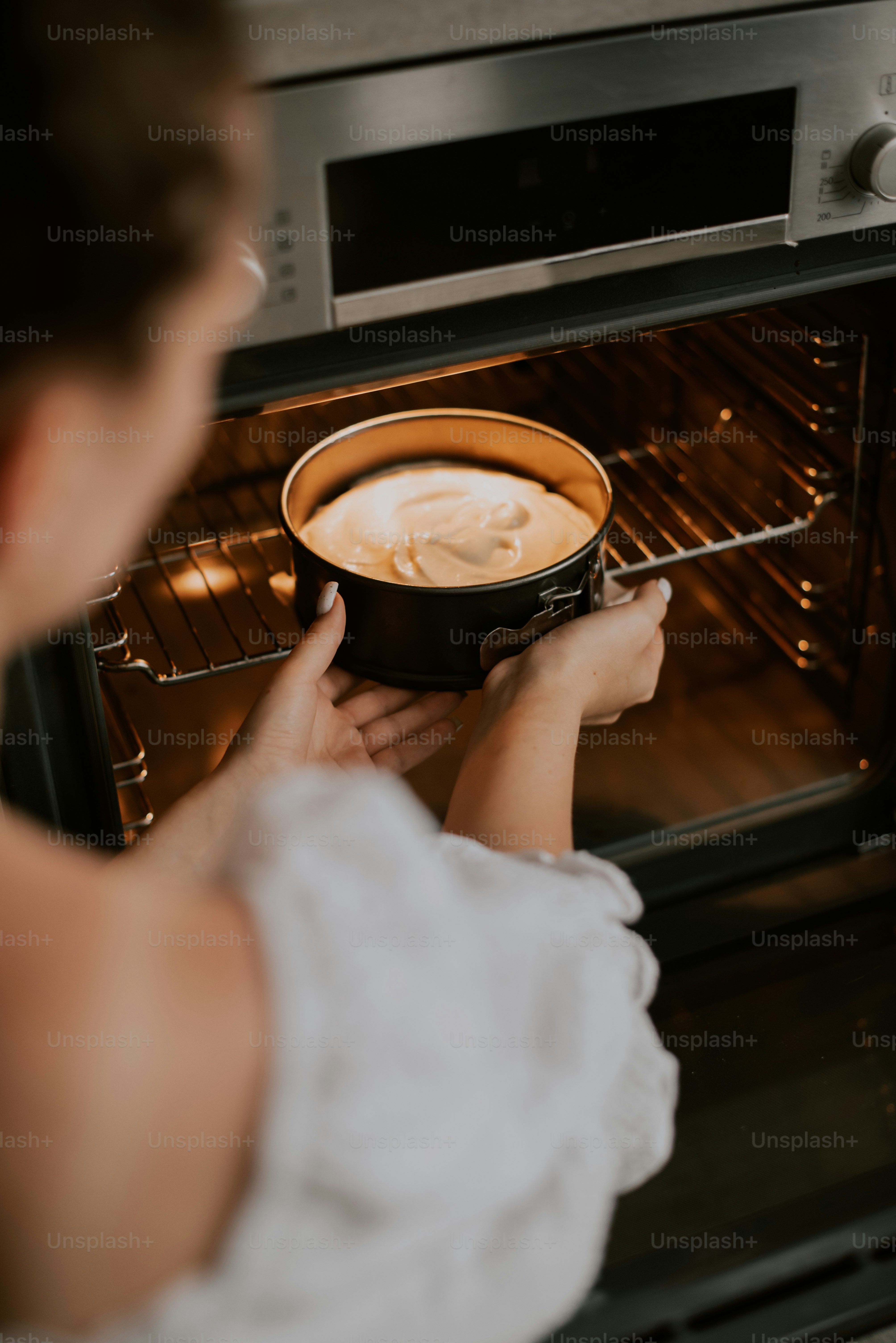 A woman is taking a pot out of the oven photo – Oven Image on Unsplash