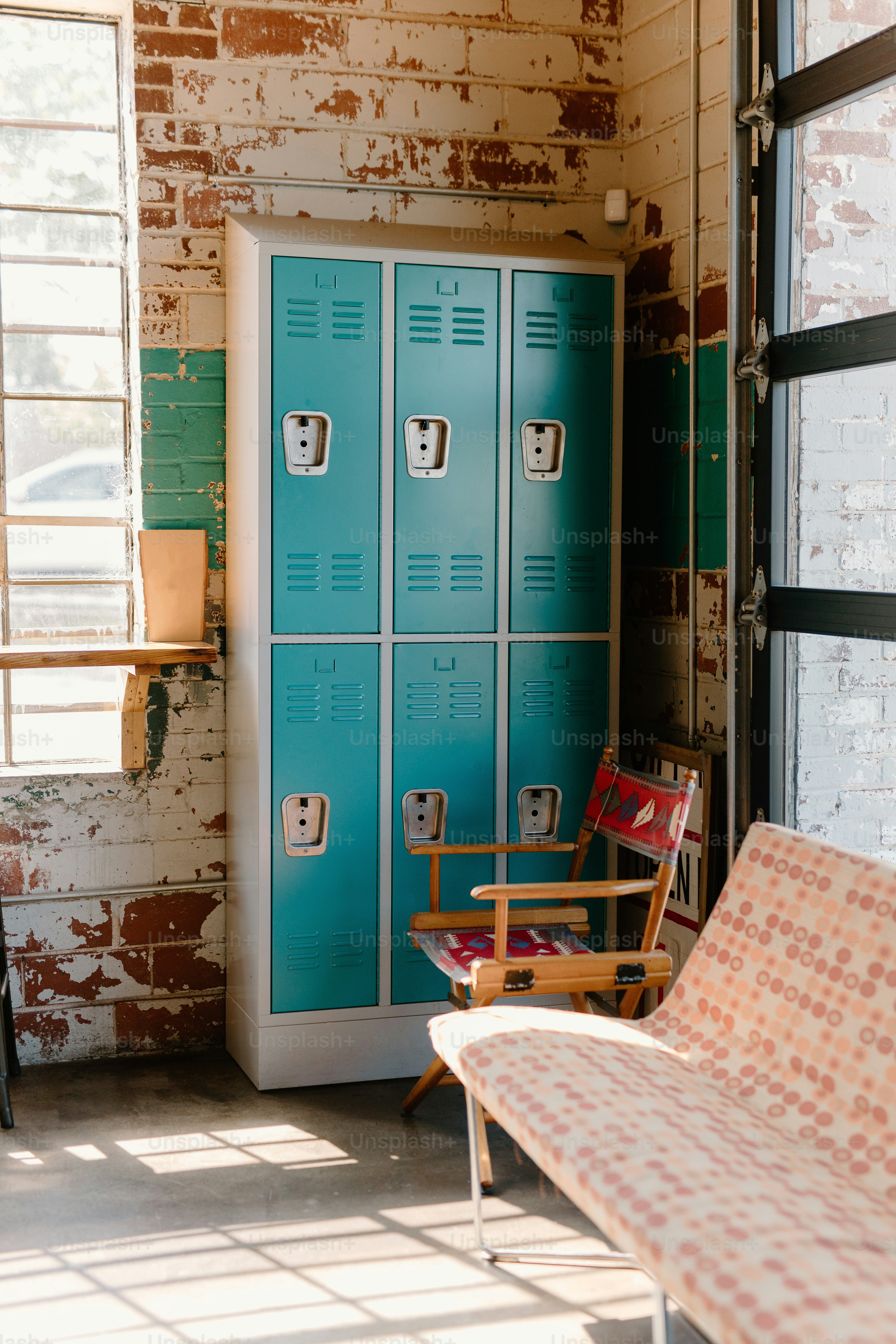 A blue locker sitting next to a wooden bench photo – Industrial ...
