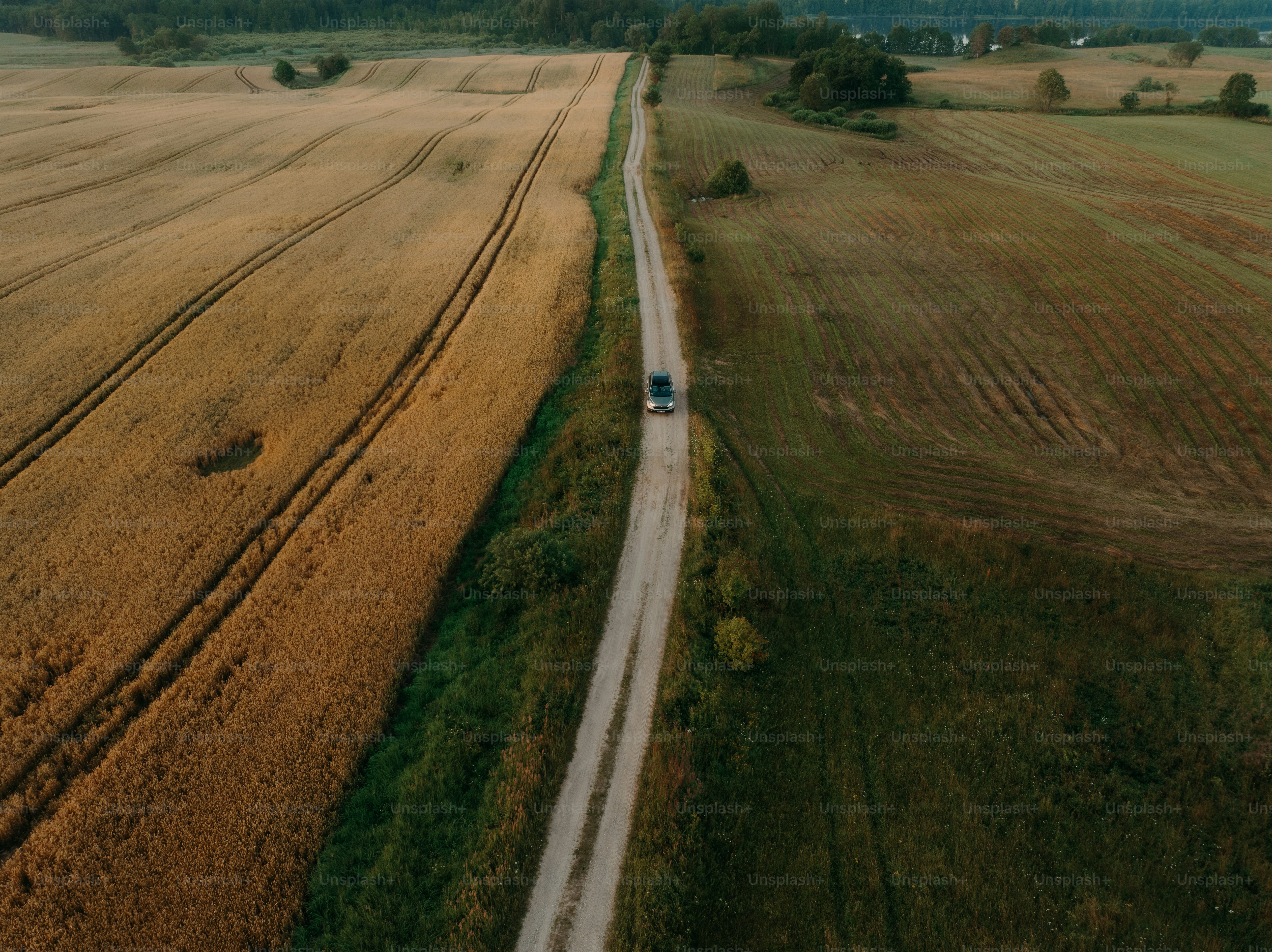 An aerial view of a truck driving down a country road photo – Farm ...