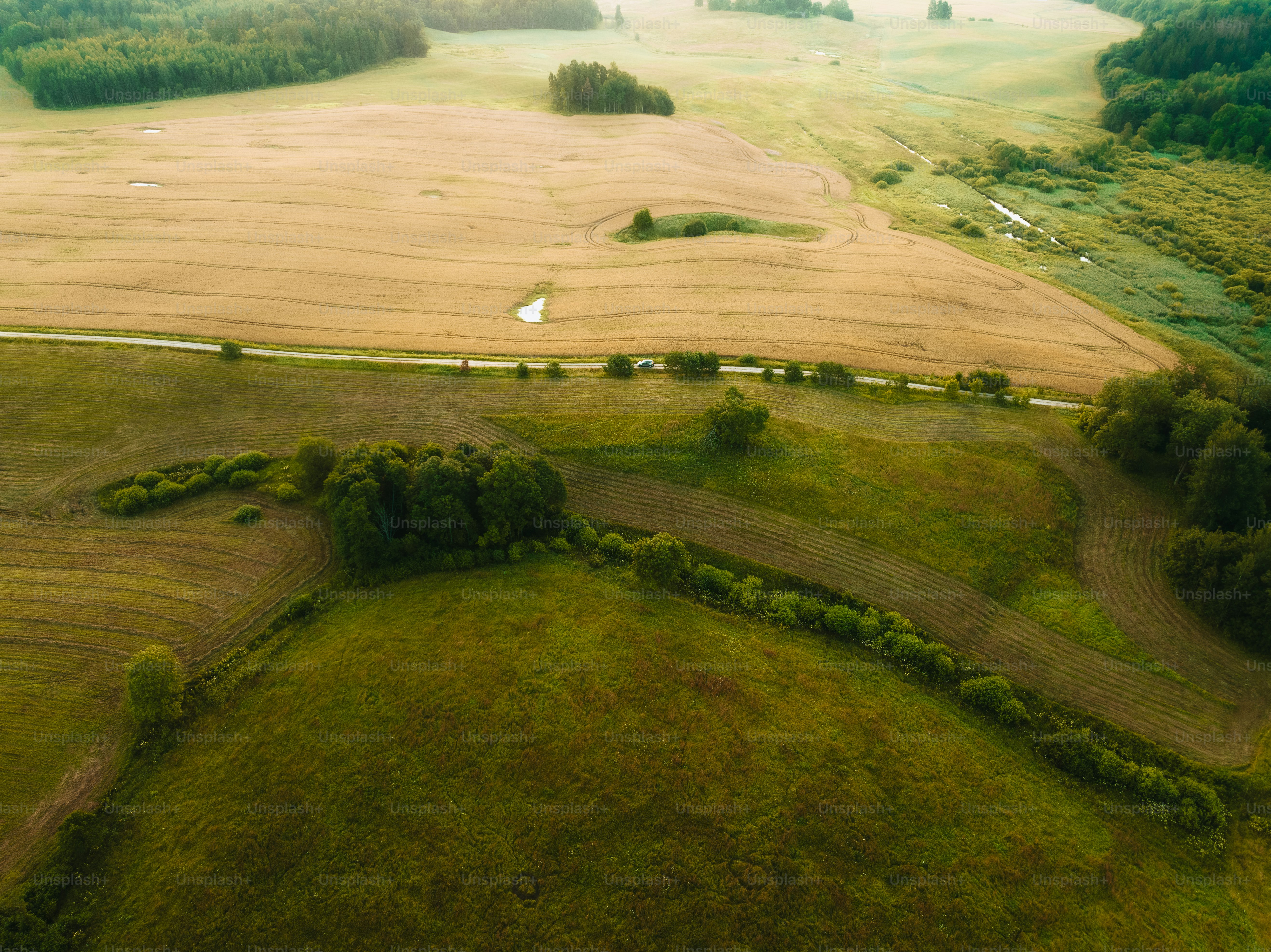 An aerial view of a farm land with a river running through it photo ...