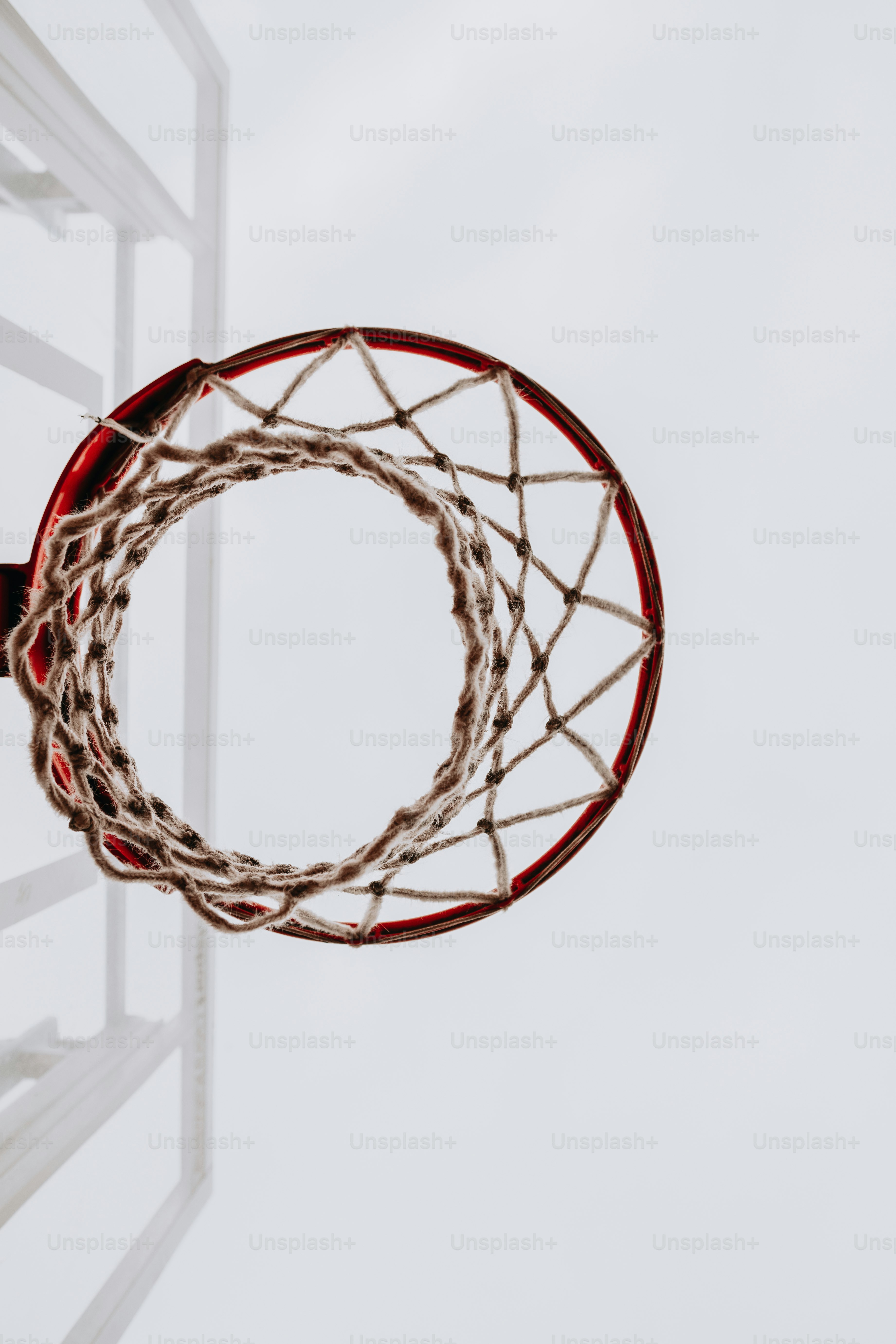A basketball going through the rim of a basketball hoop photo ...