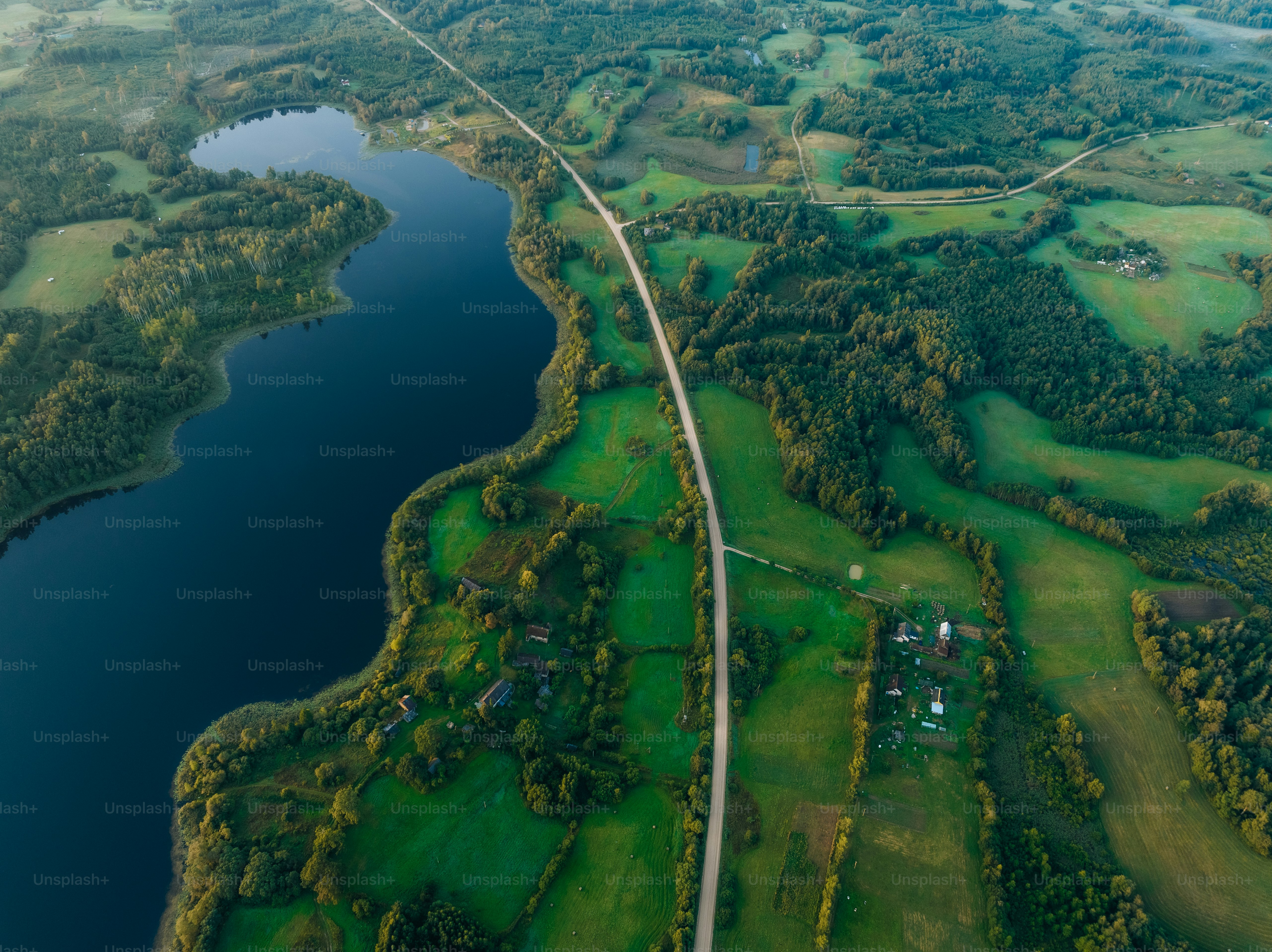 An aerial view of a golf course and a river photo – Forest lake Image ...