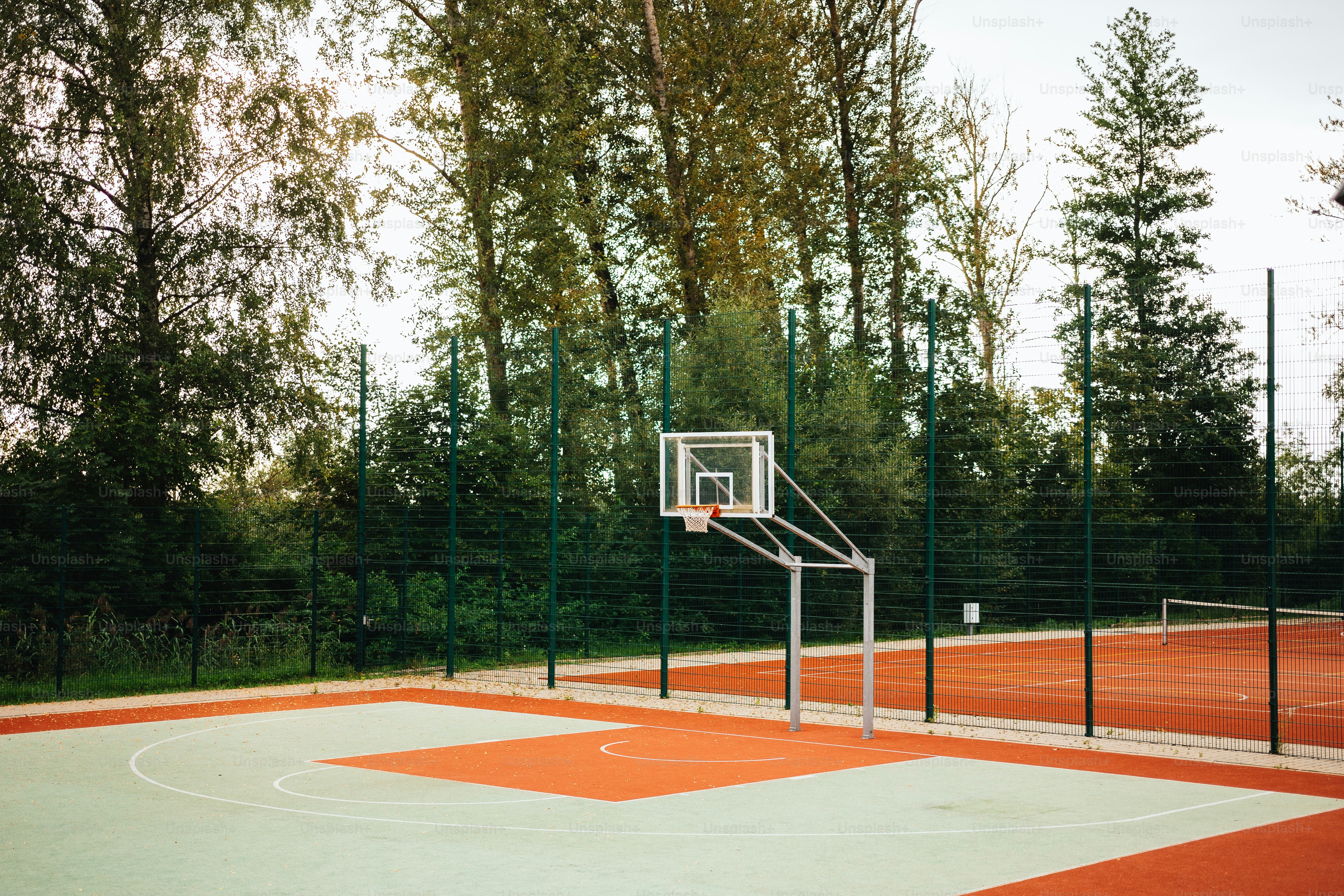 A basketball court with a basketball hoop in the middle of it photo ...