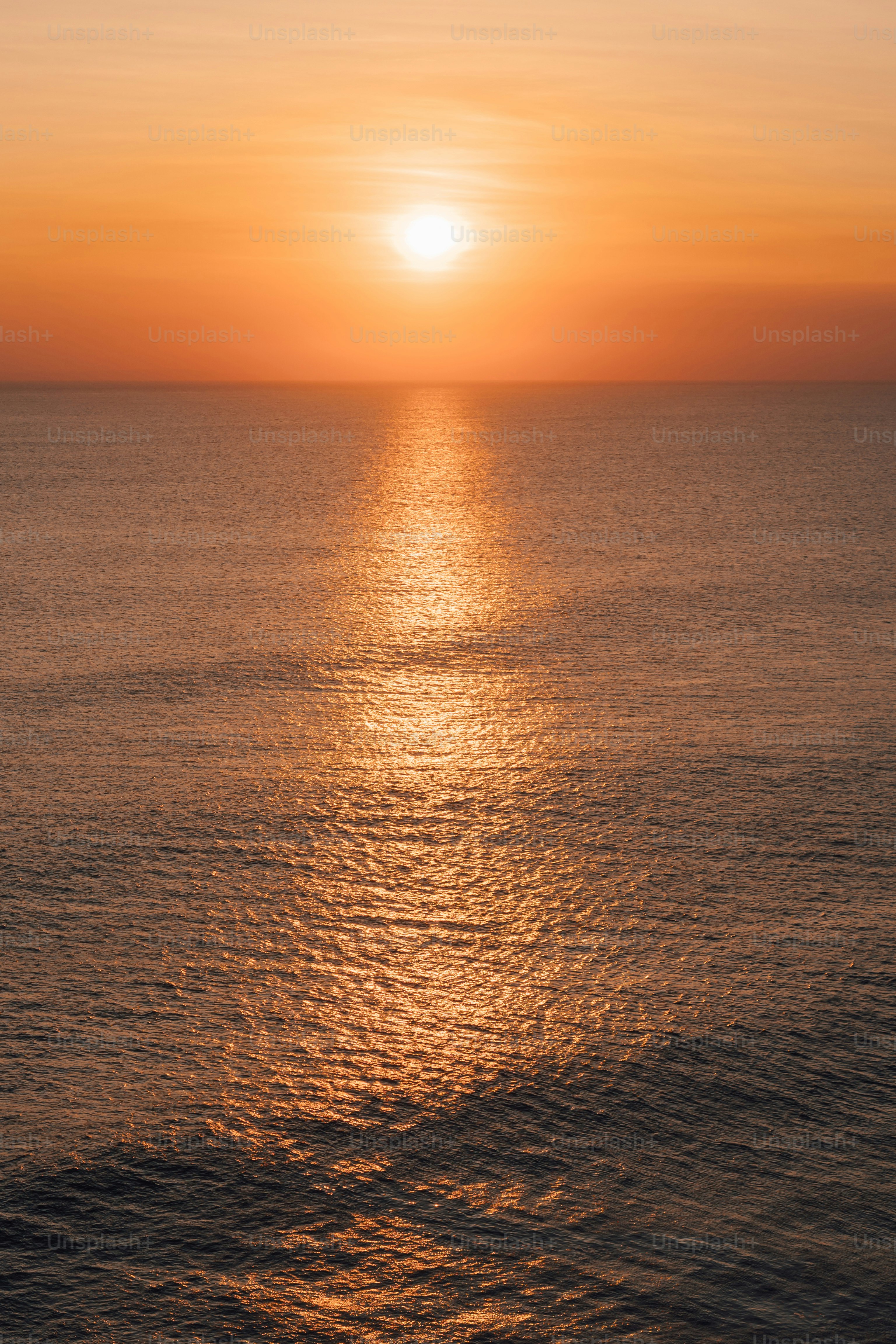 The sun is setting over the ocean on a clear day photo – Sunset view ...