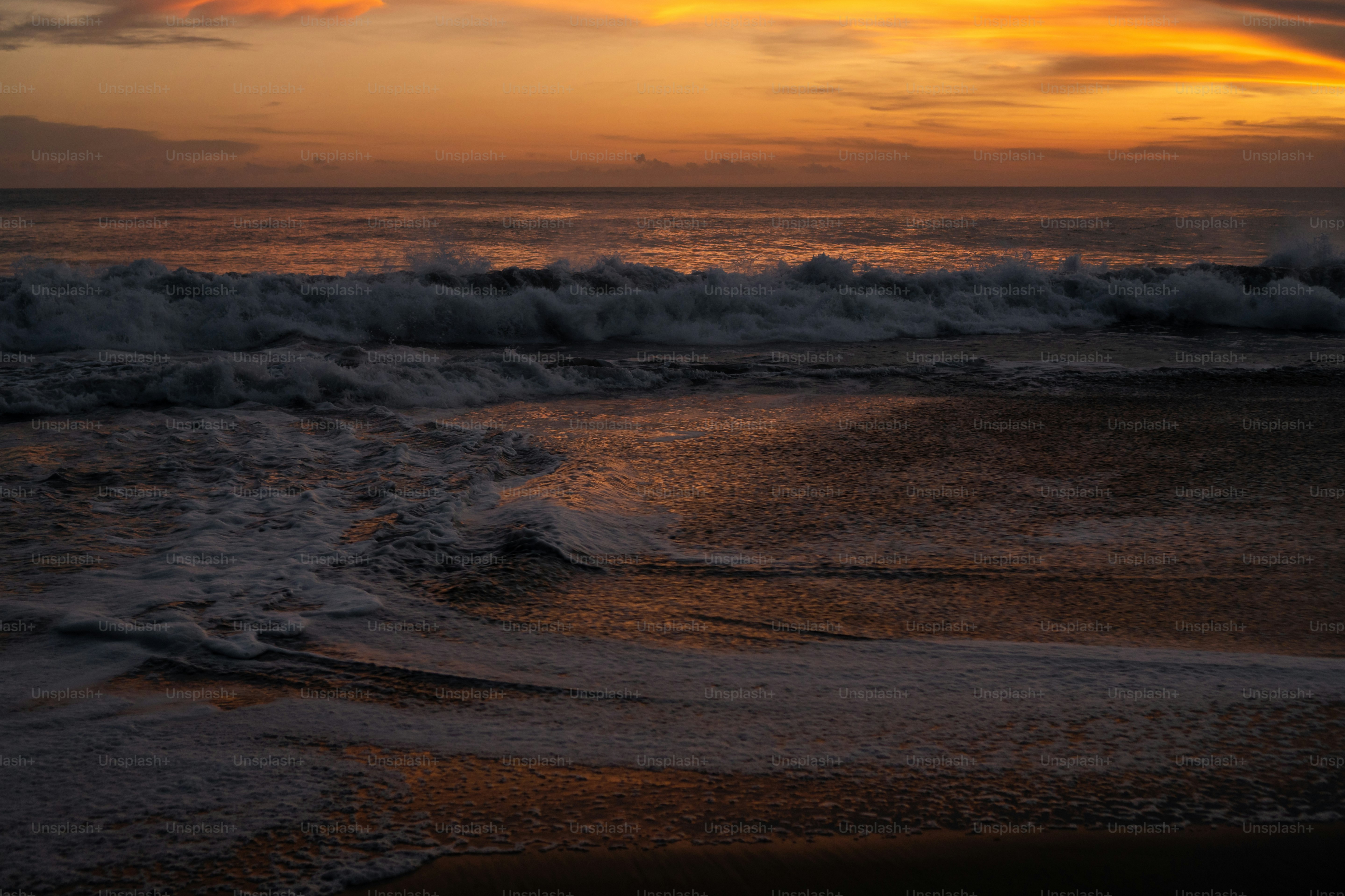 The sun is setting over the ocean on a clear day photo – Beach Image on ...