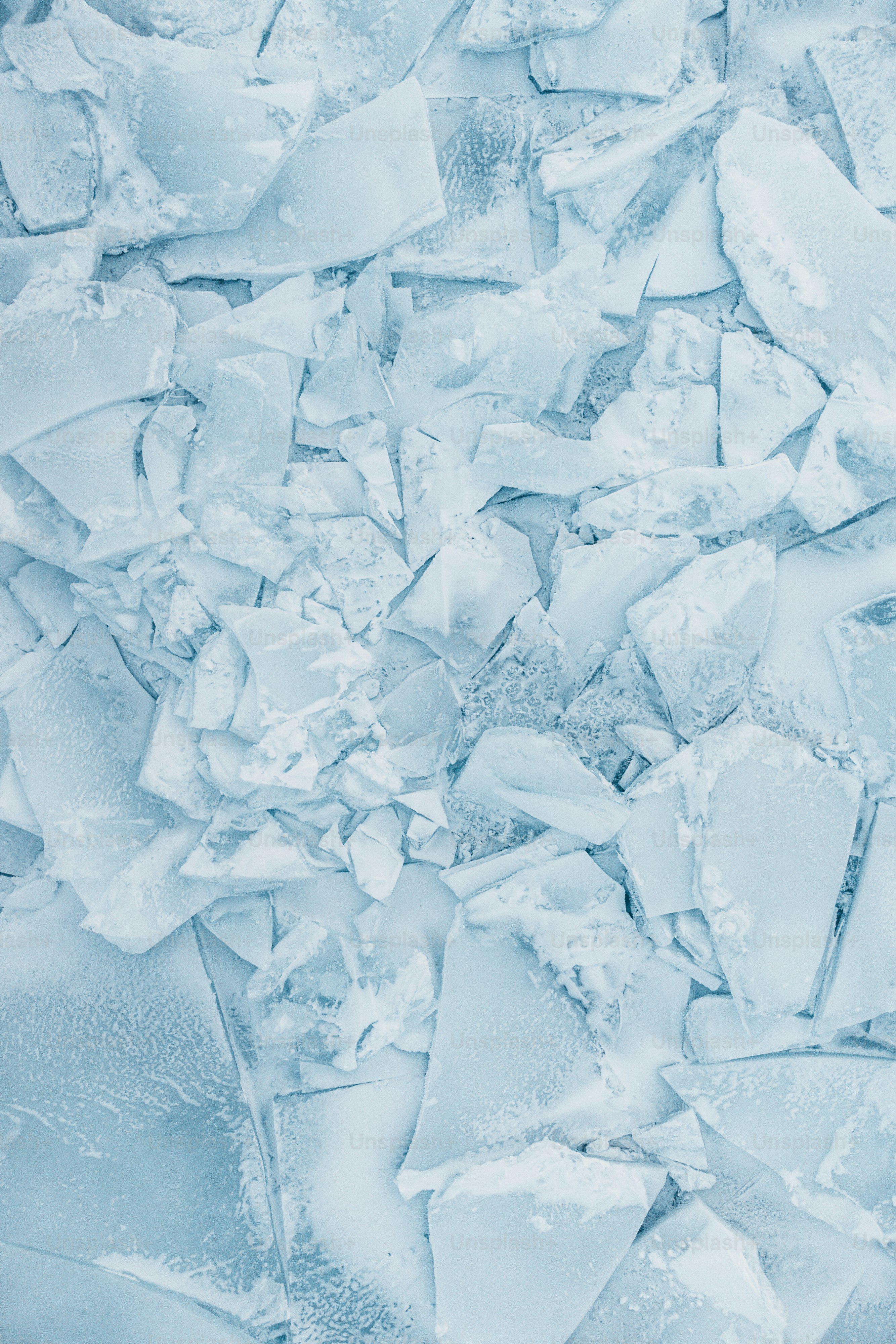 A pile of ice chunks sitting on top of a snow covered ground photo ...