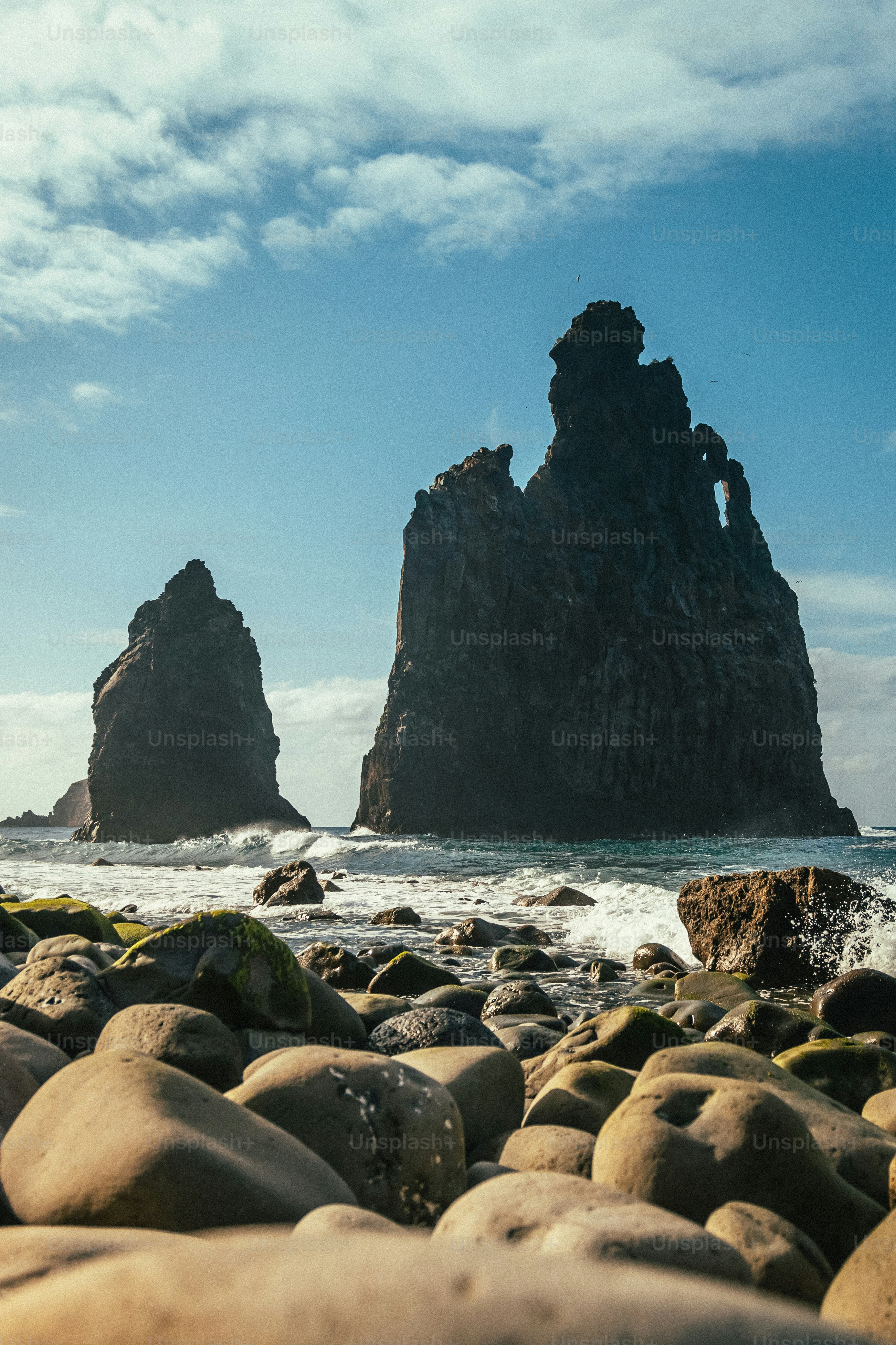 A rocky beach with large rocks in the foreground photo – Beach Image on ...