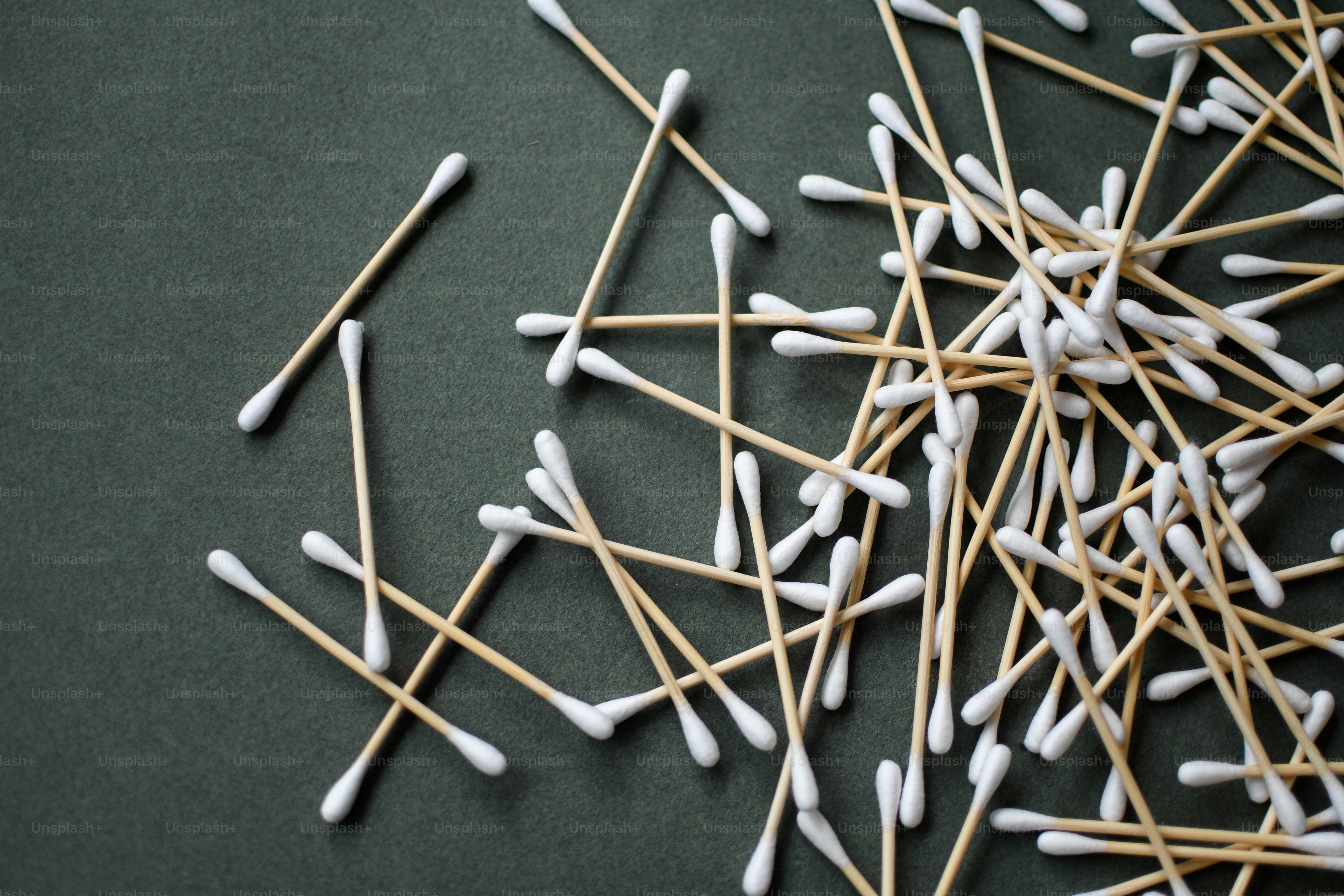 A pile of toothpicks sitting on top of a table photo – Q-tip Image on ...