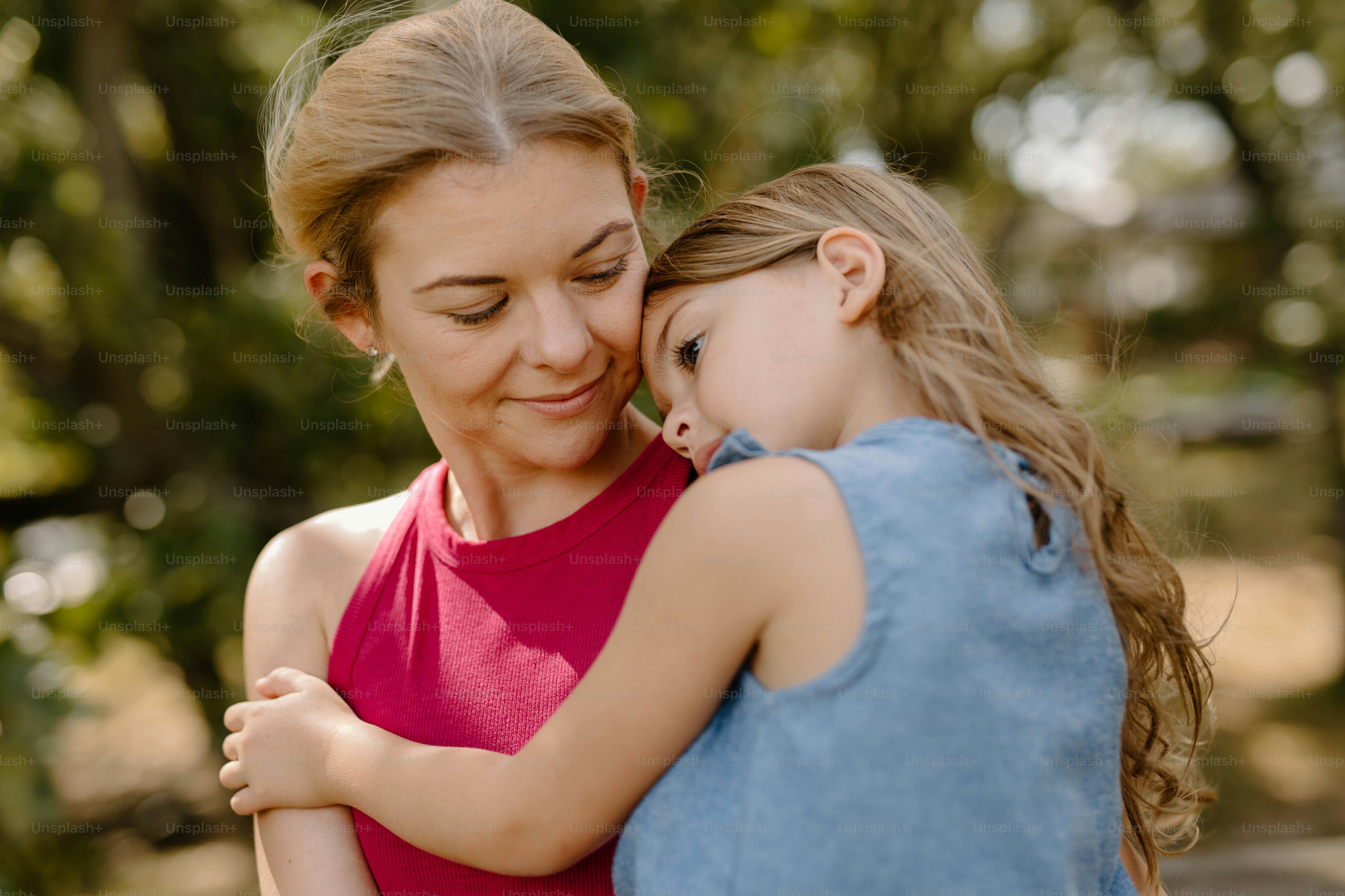 A woman holding a little girl in her arms photo – Girl Image on Unsplash