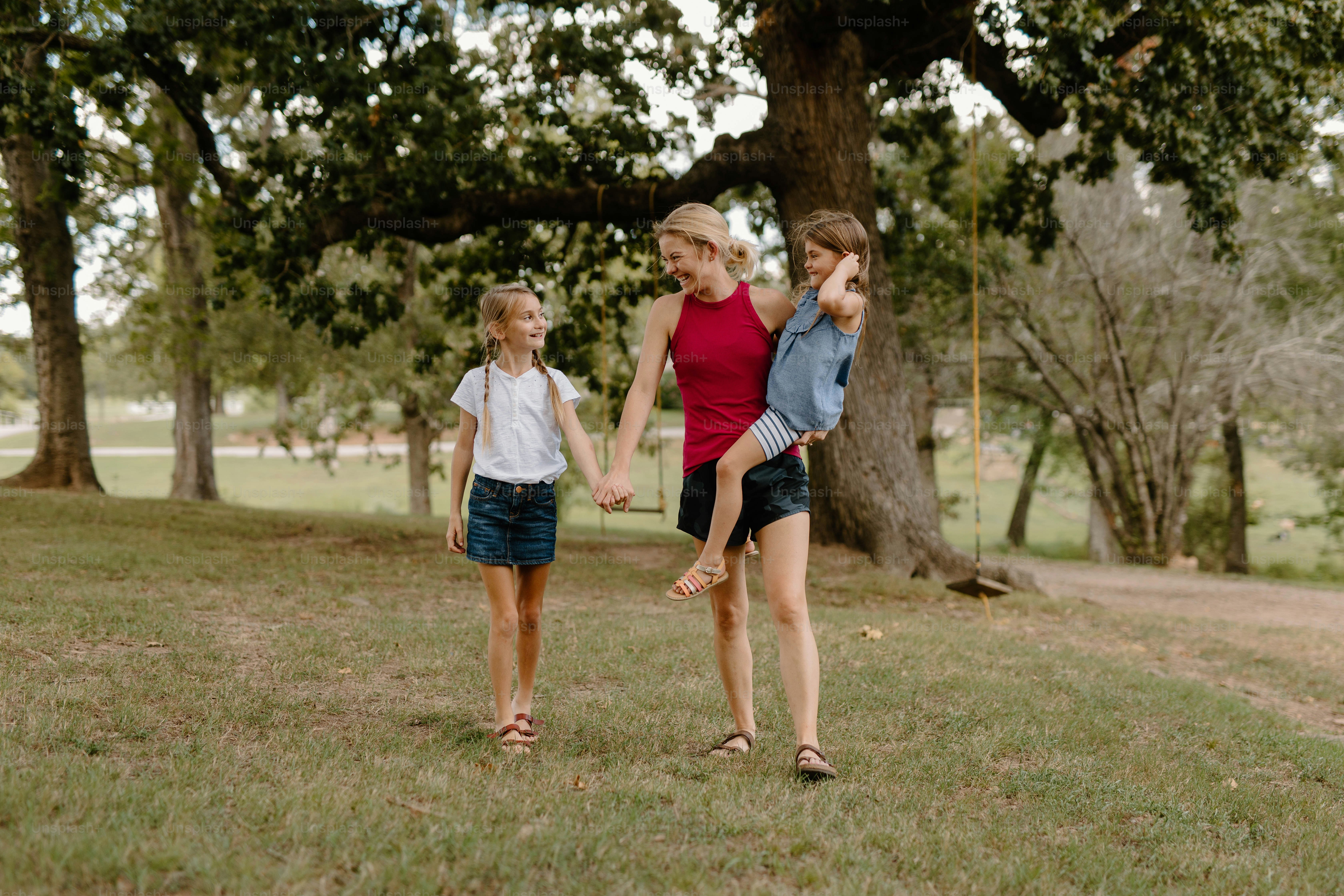 A group of young girls walking across a lush green field photo – Happy ...