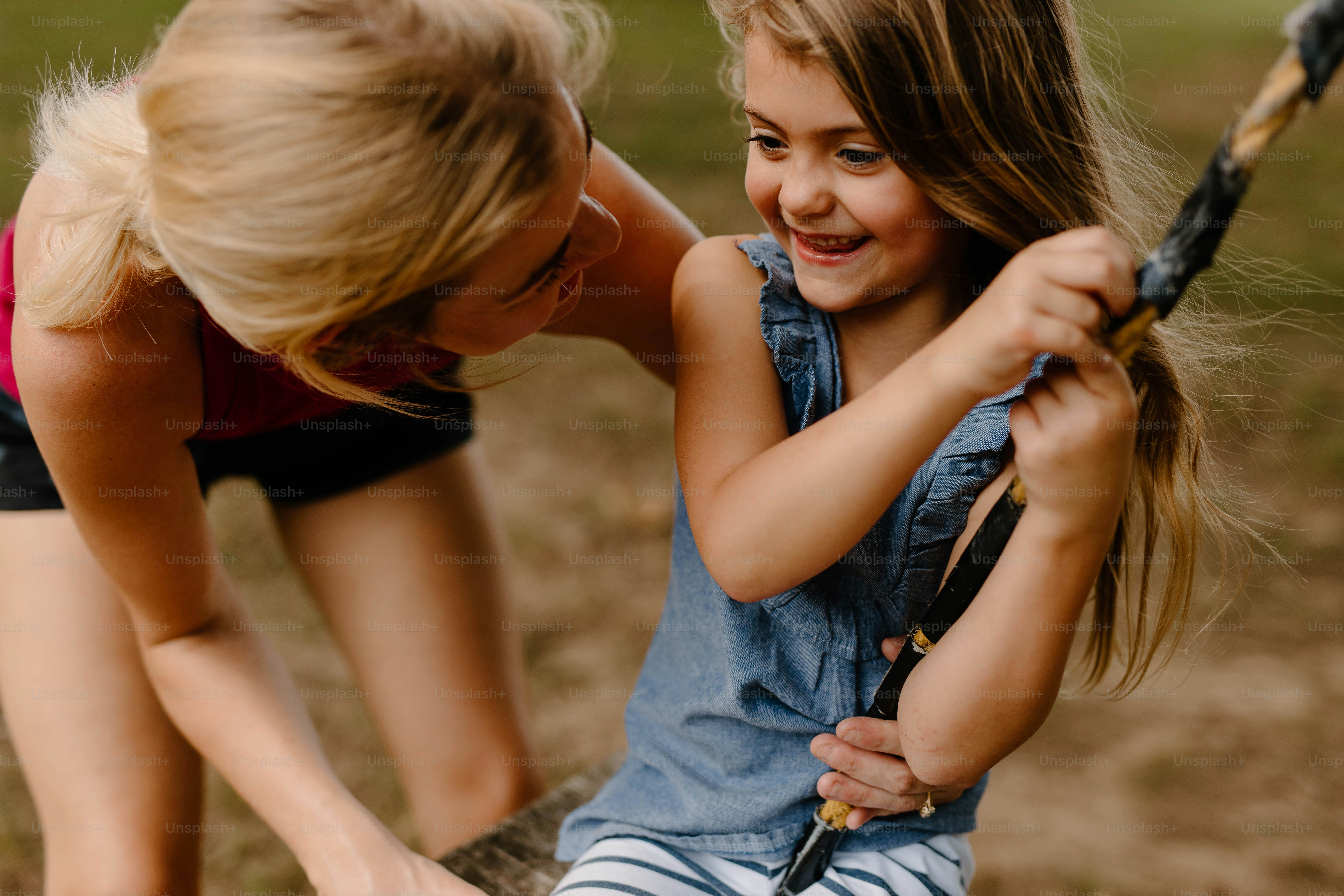 Two young girls playing baseball together in a field photo – Mum Image ...
