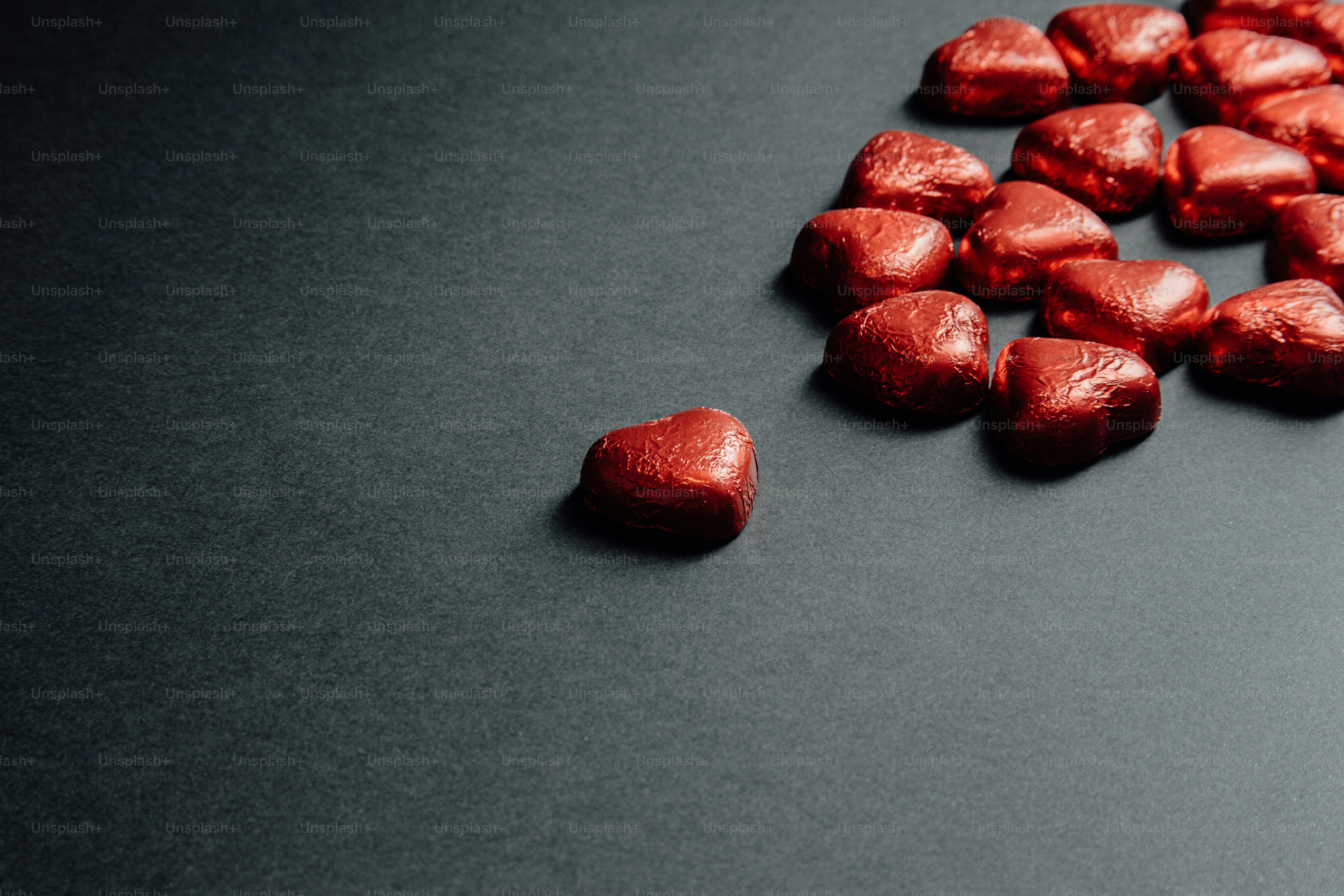 A heart shaped chocolate candy sitting on top of a table photo ...