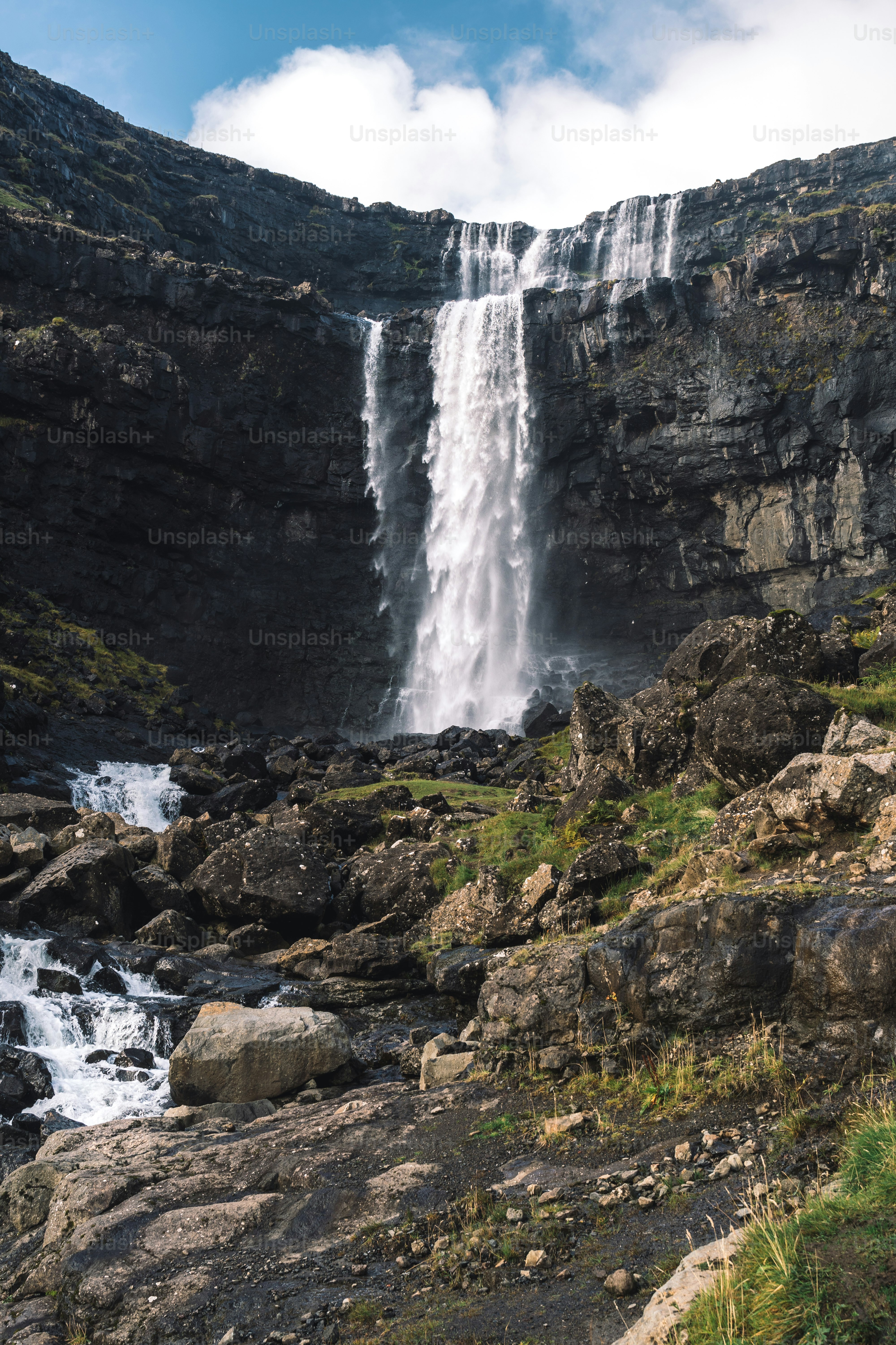 A very tall waterfall with a bunch of water coming out of it photo ...