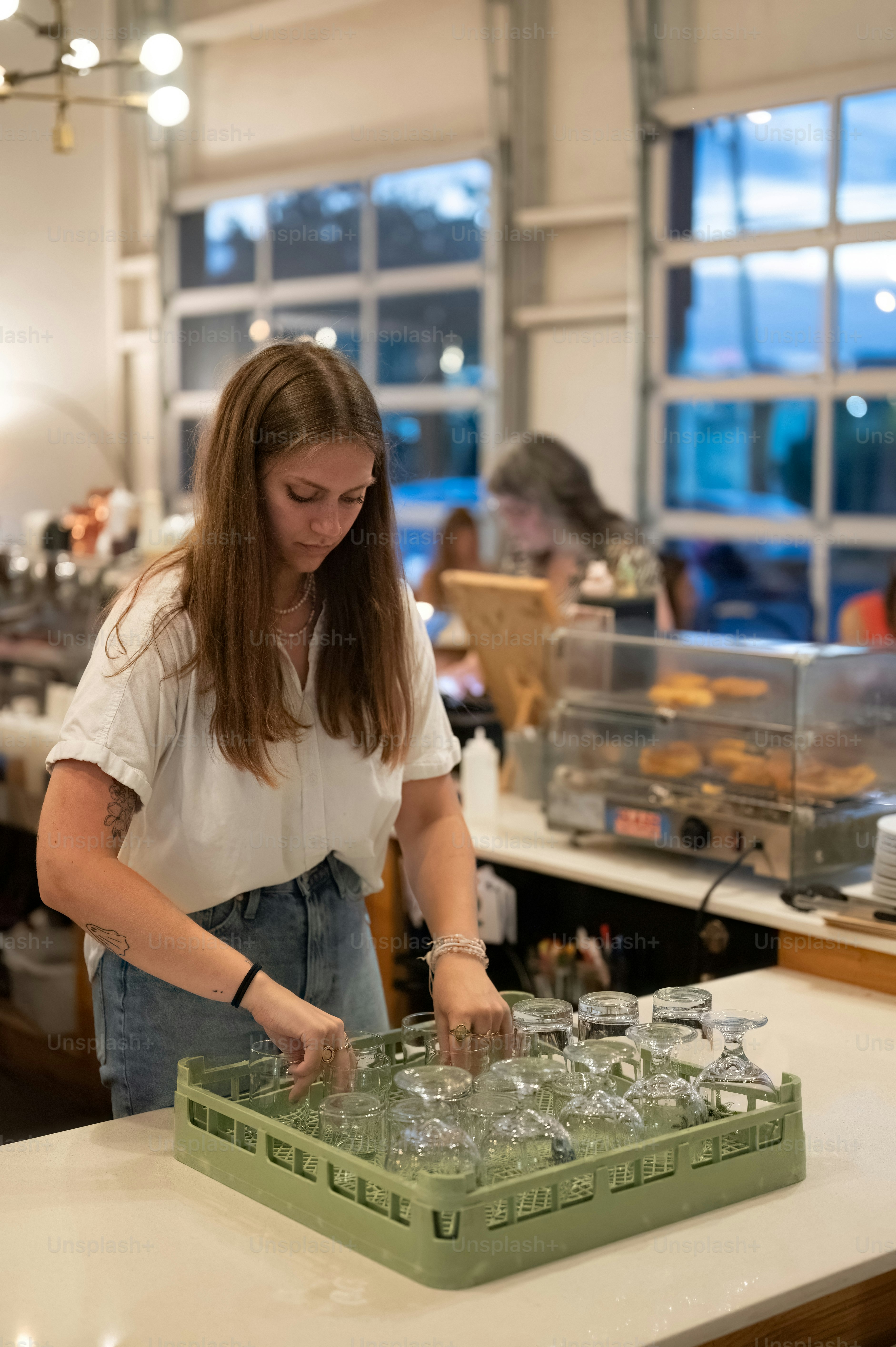 A man standing behind a counter in a store photo – Resturant Image on ...