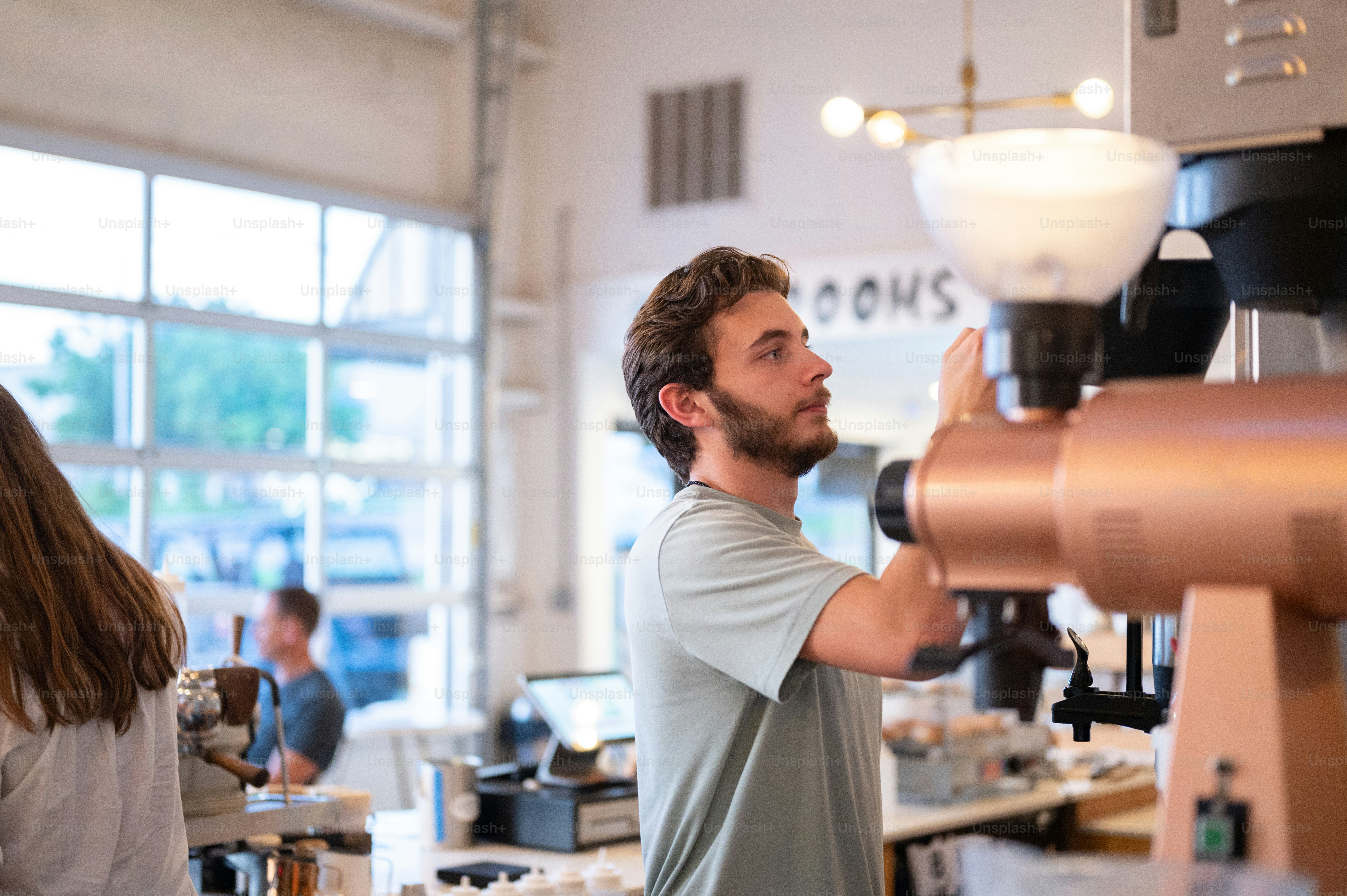 A man working on a coffee machine in a coffee shop photo – Restaurant ...
