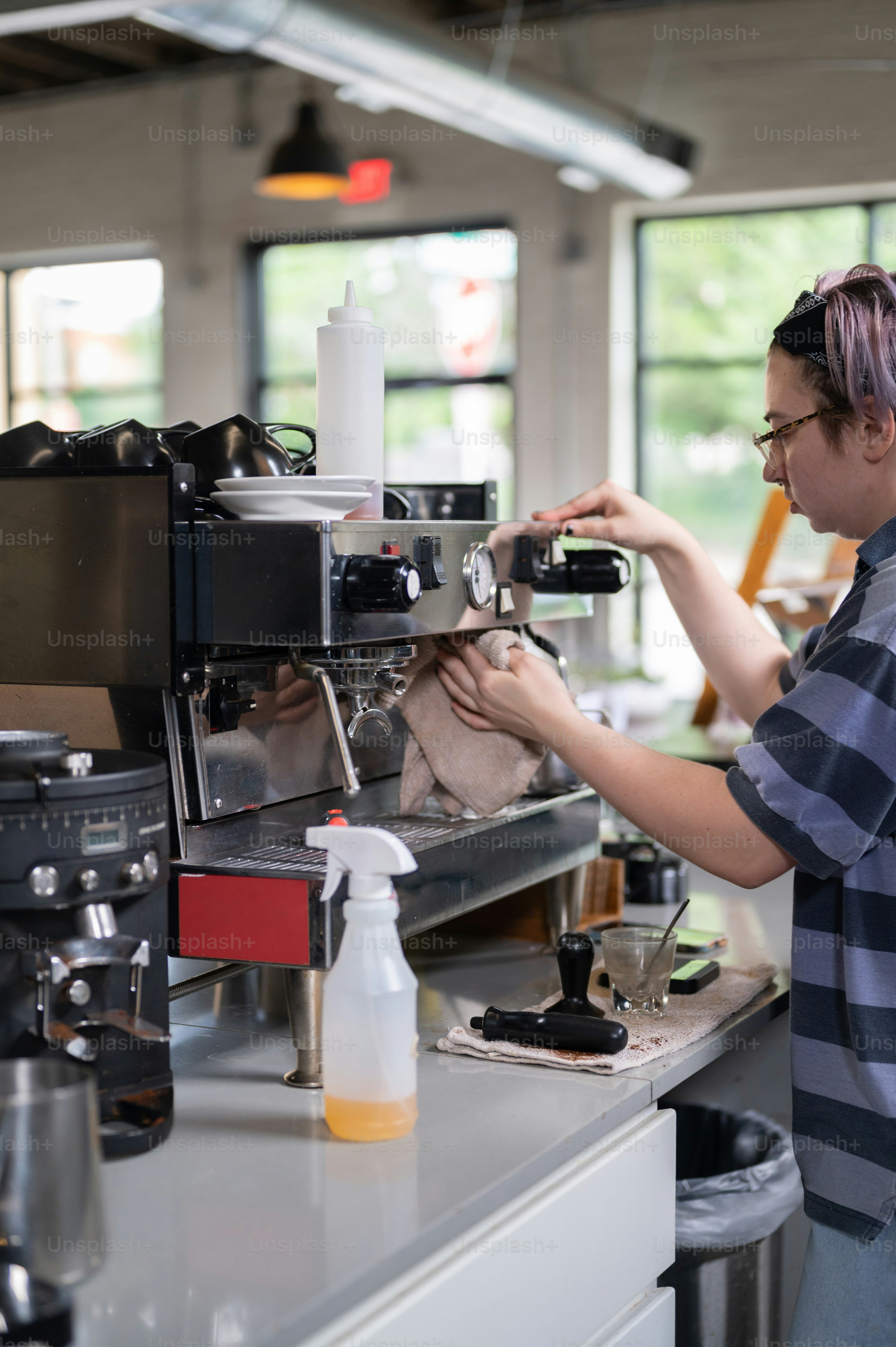 A coffee machine sitting on top of a metal counter photo – Café Image ...