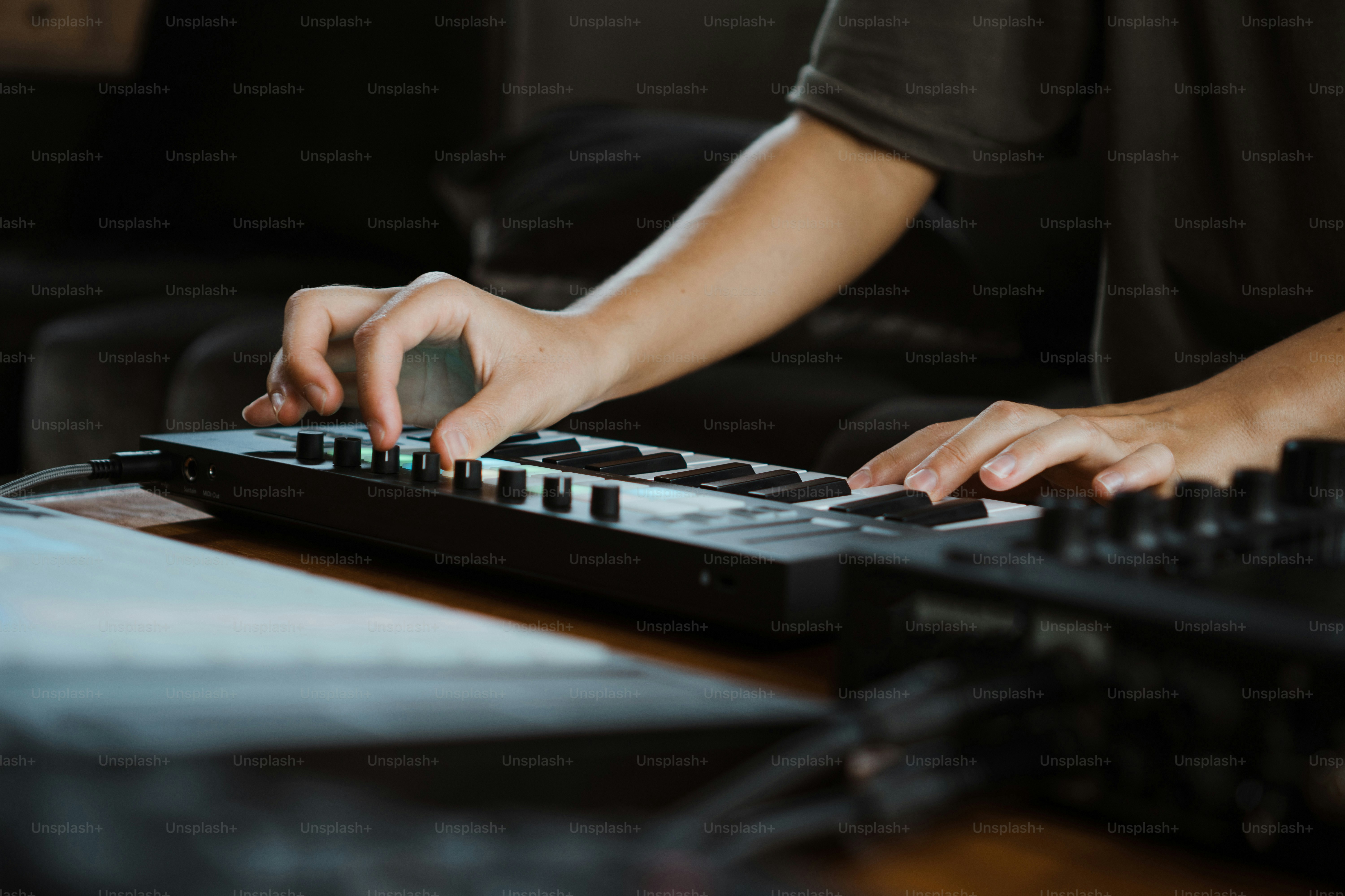 A person typing on a keyboard with their hands photo – Music studio ...