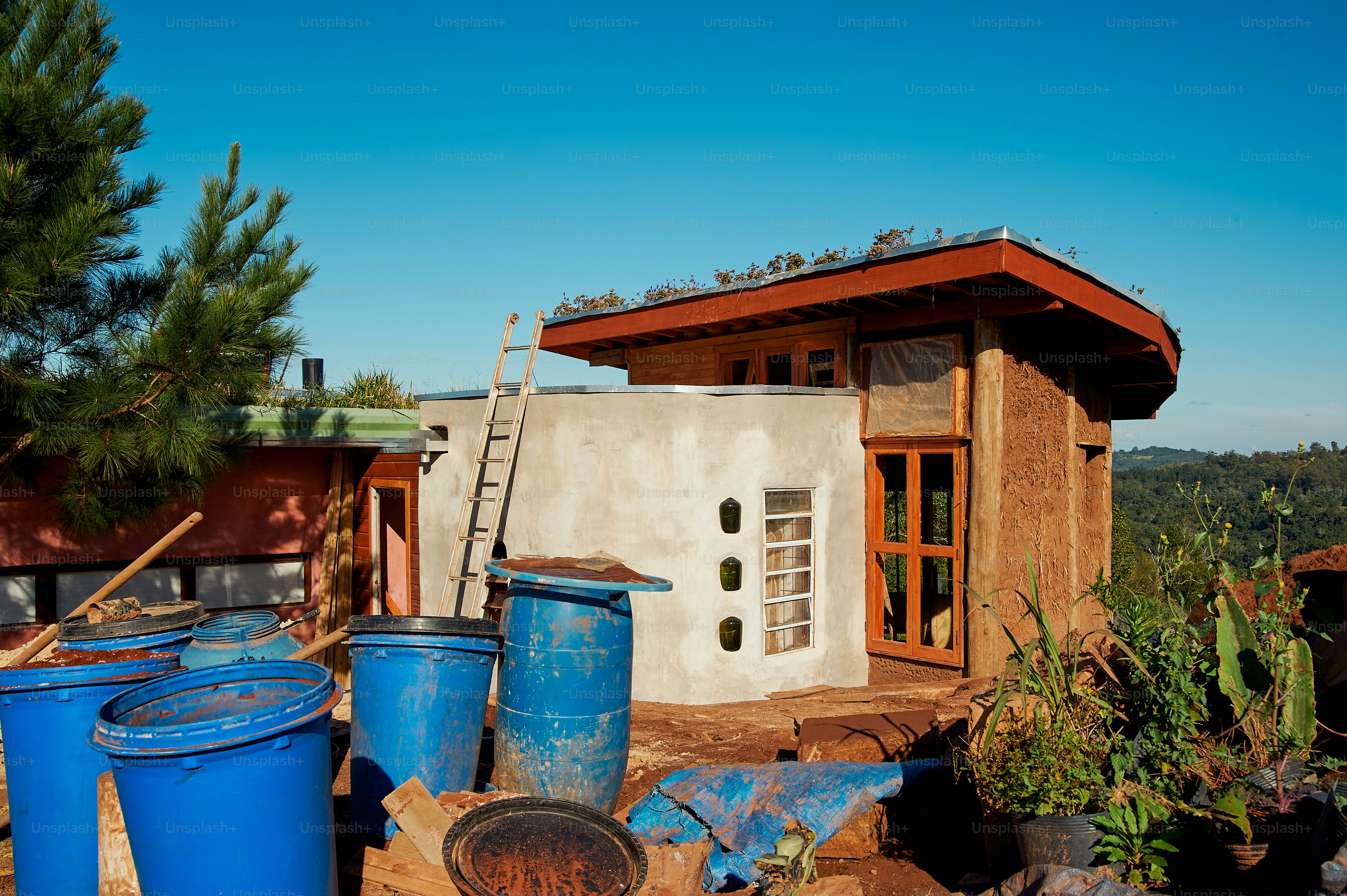 A house that is being built with buckets and a ladder photo ...