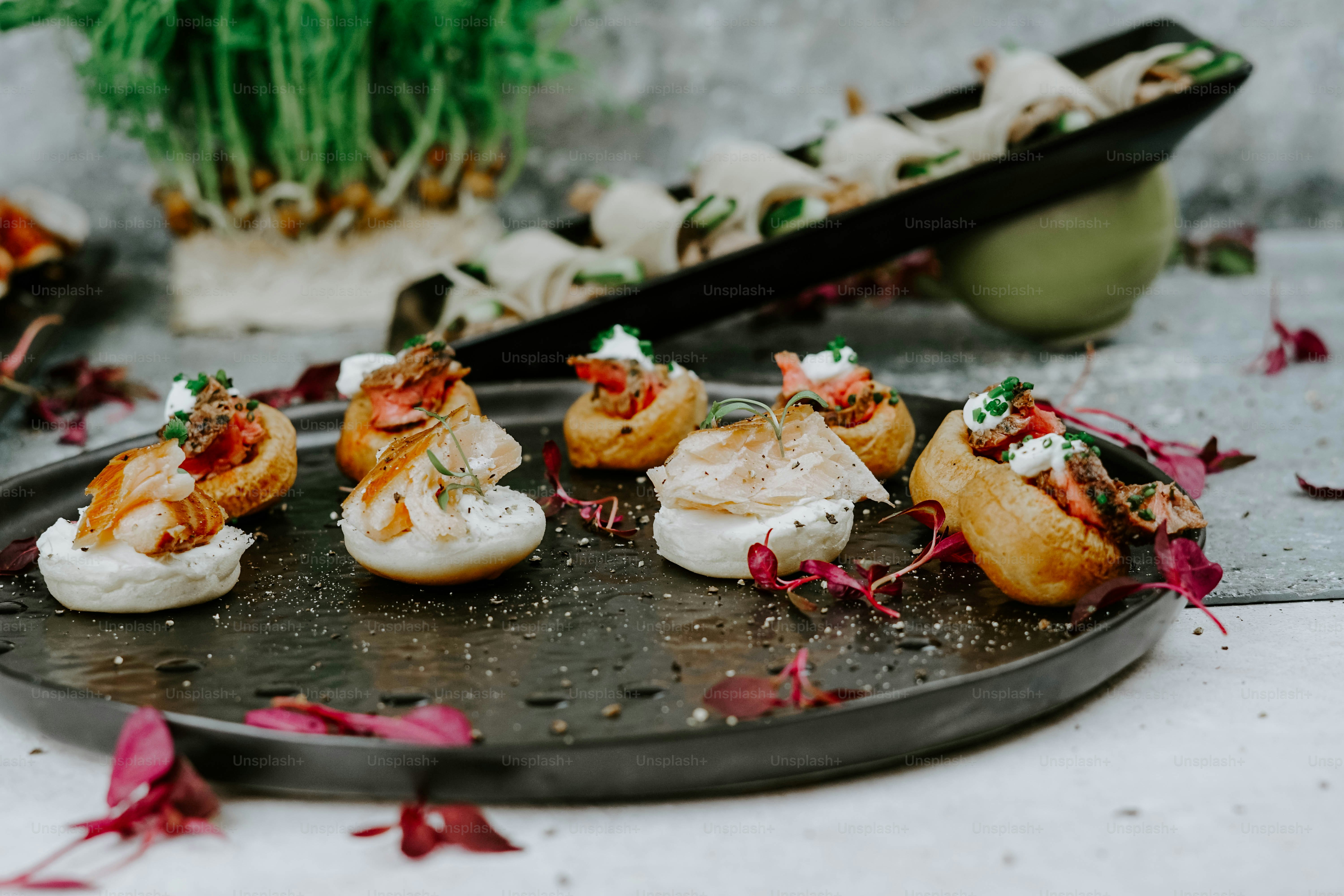 A plate of appetizers on a table photo – Food presentation Image on ...