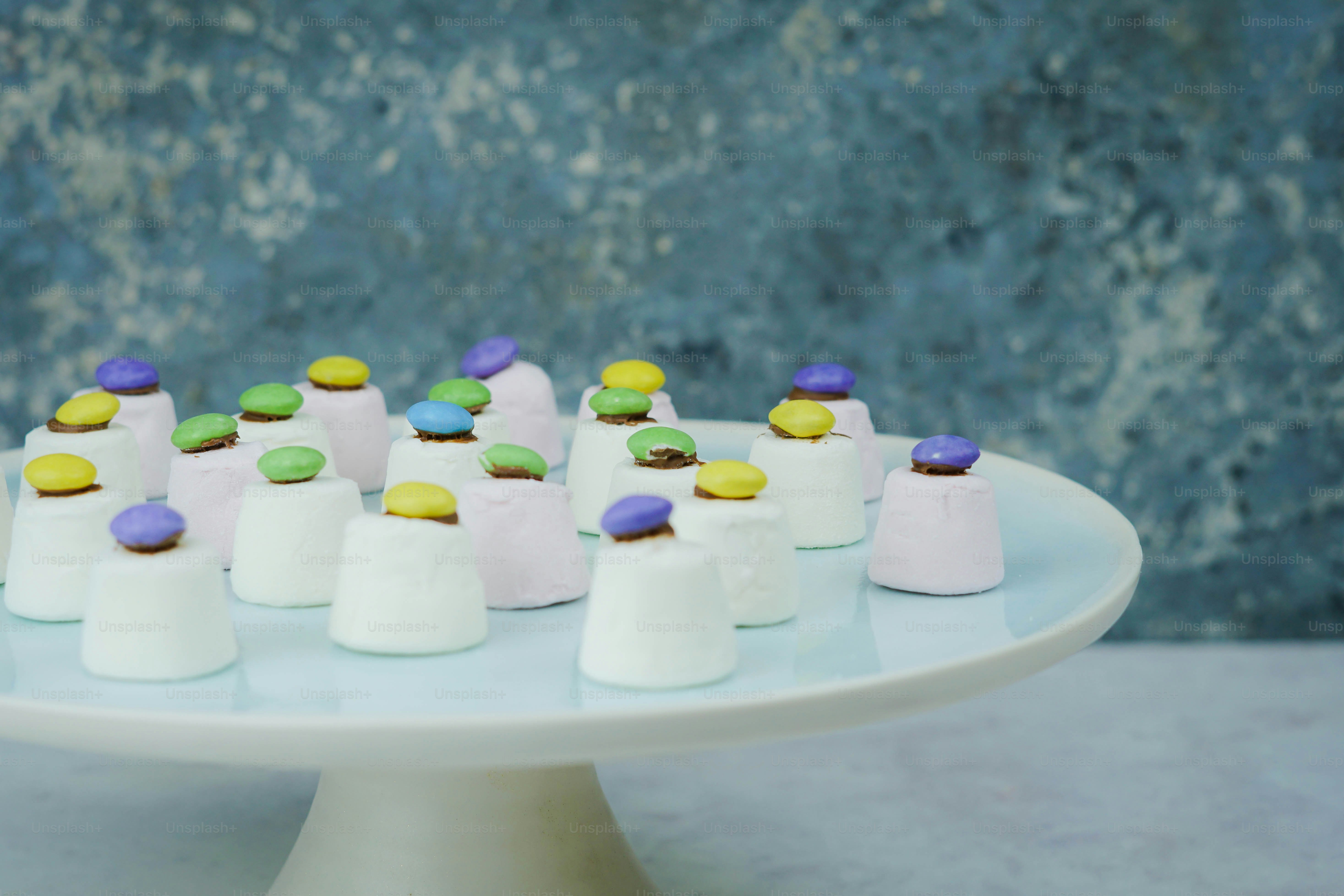 A white plate topped with lots of marshmallows photo – Cake background ...
