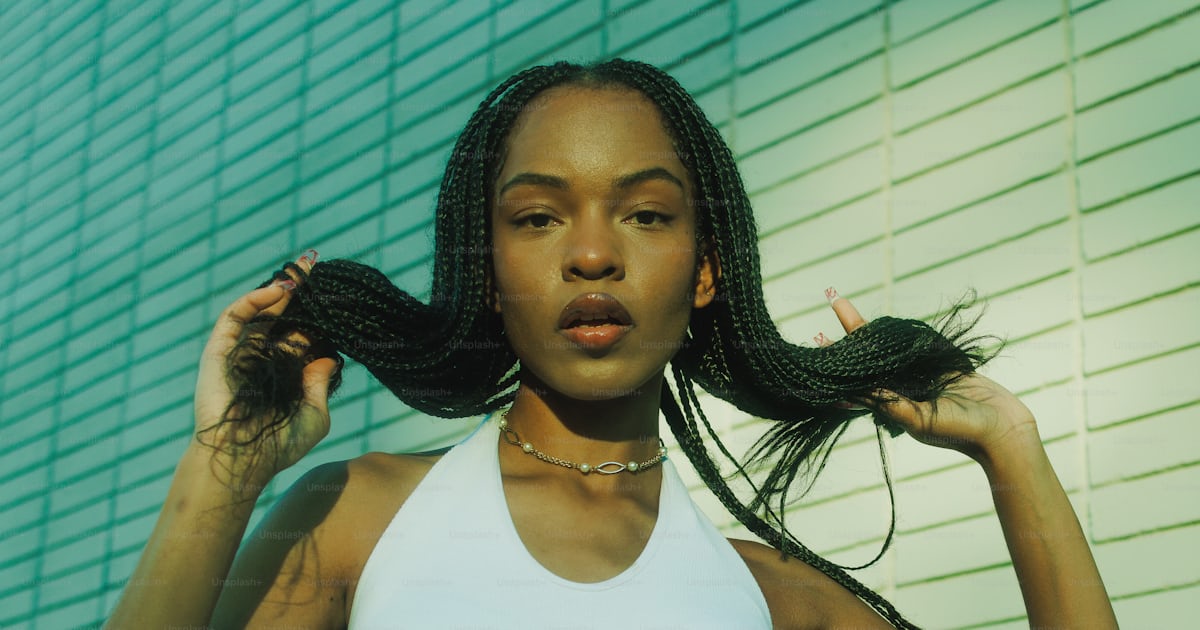 A Woman In A White Tank Top Holding Her Hair Photo Model Girl Image