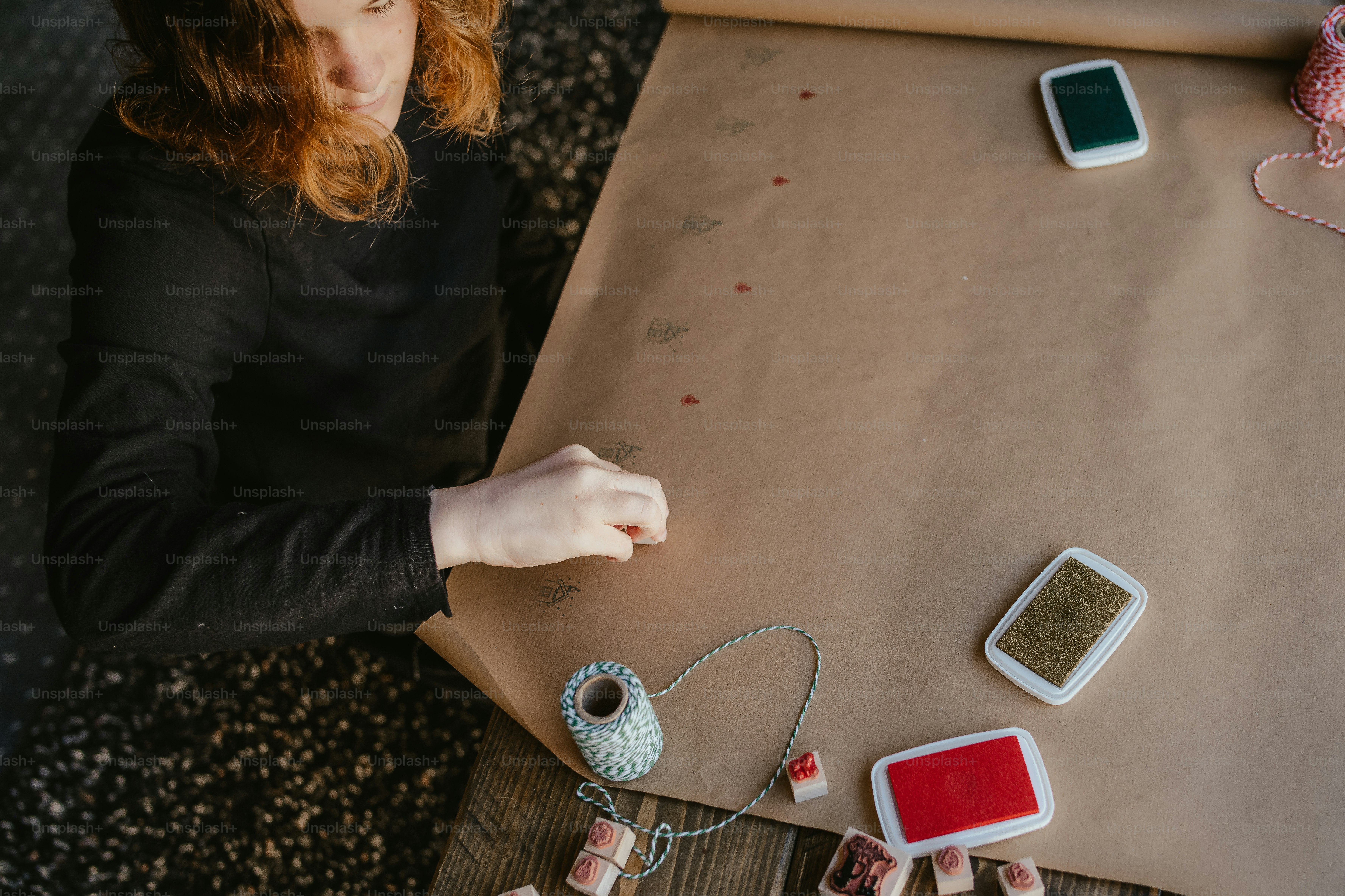A woman sitting at a table working on a craft project photo – Wrap ...