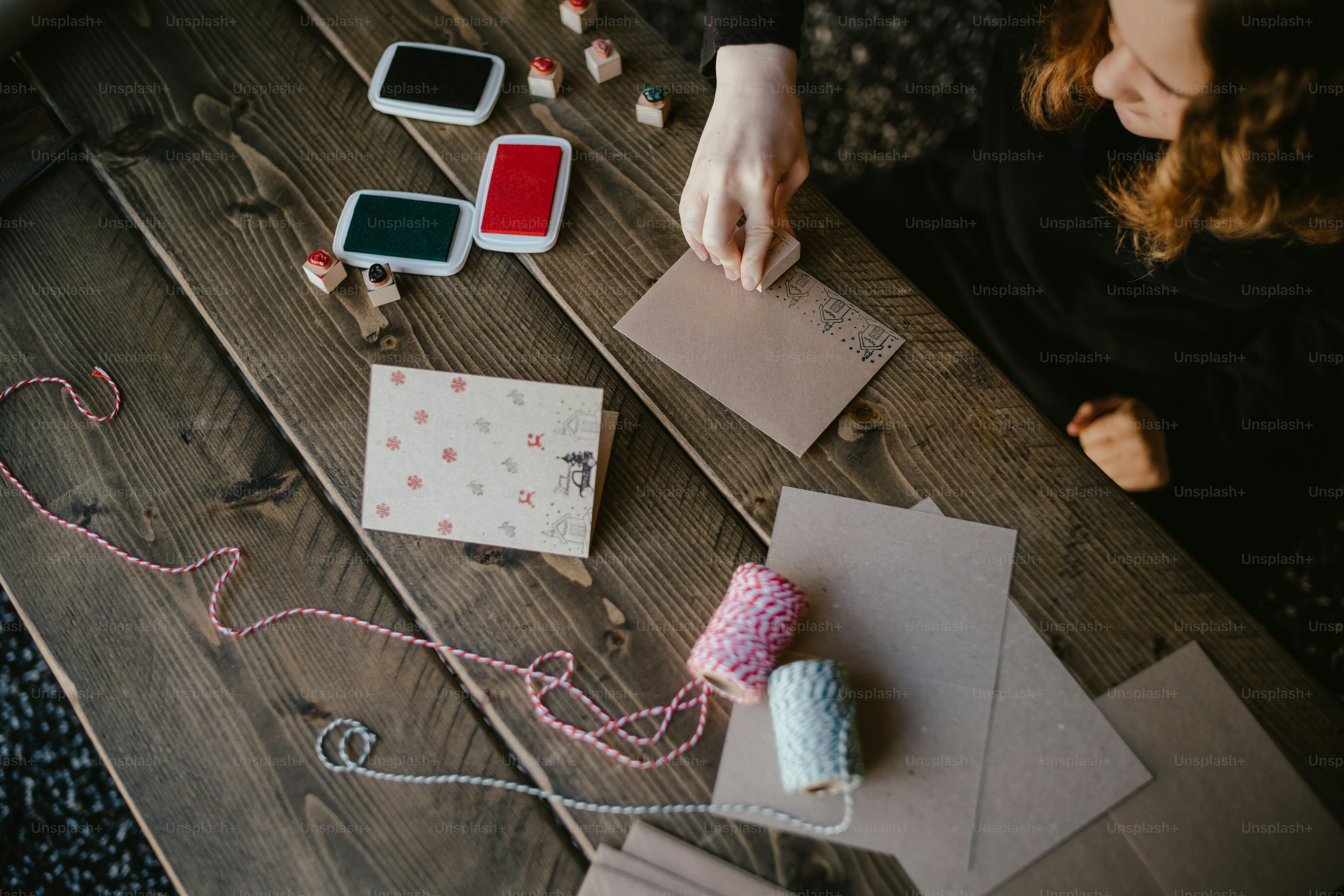 A woman sitting at a table working on a craft project photo – Christmas ...