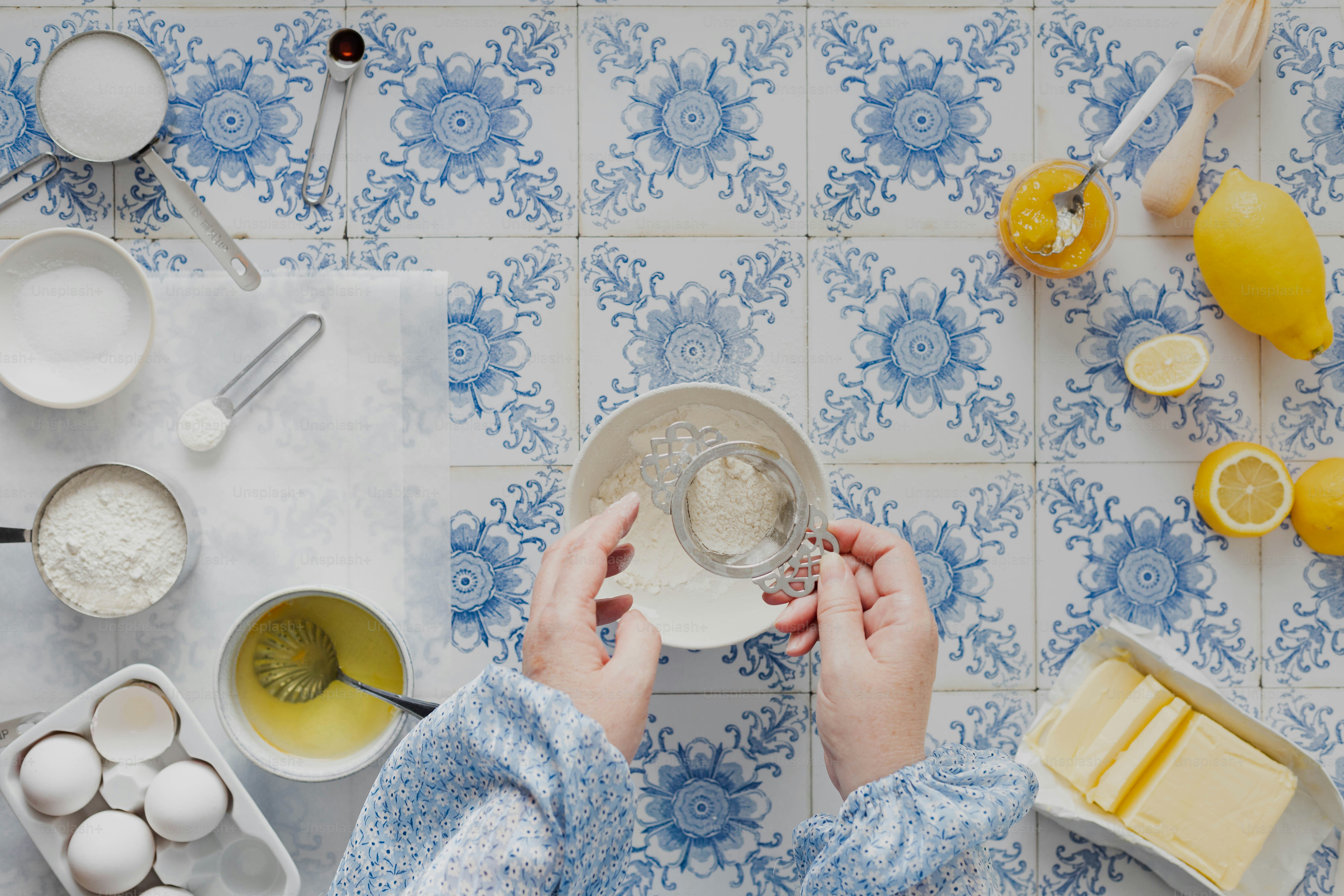 A person holding a bowl over a plate of food photo – Baking Image on ...