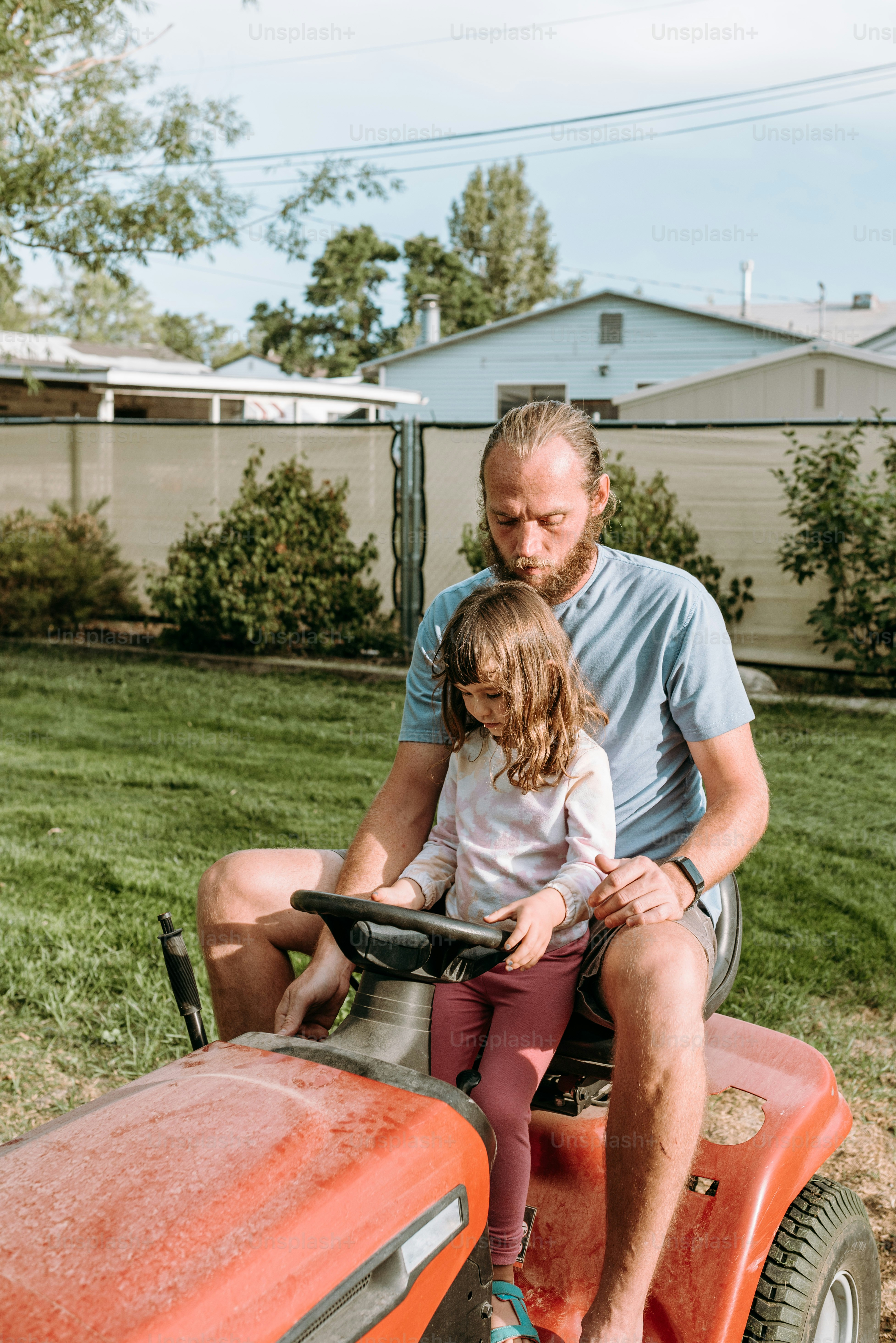 A man and a little girl sitting on a tractor photo – Father Image on ...