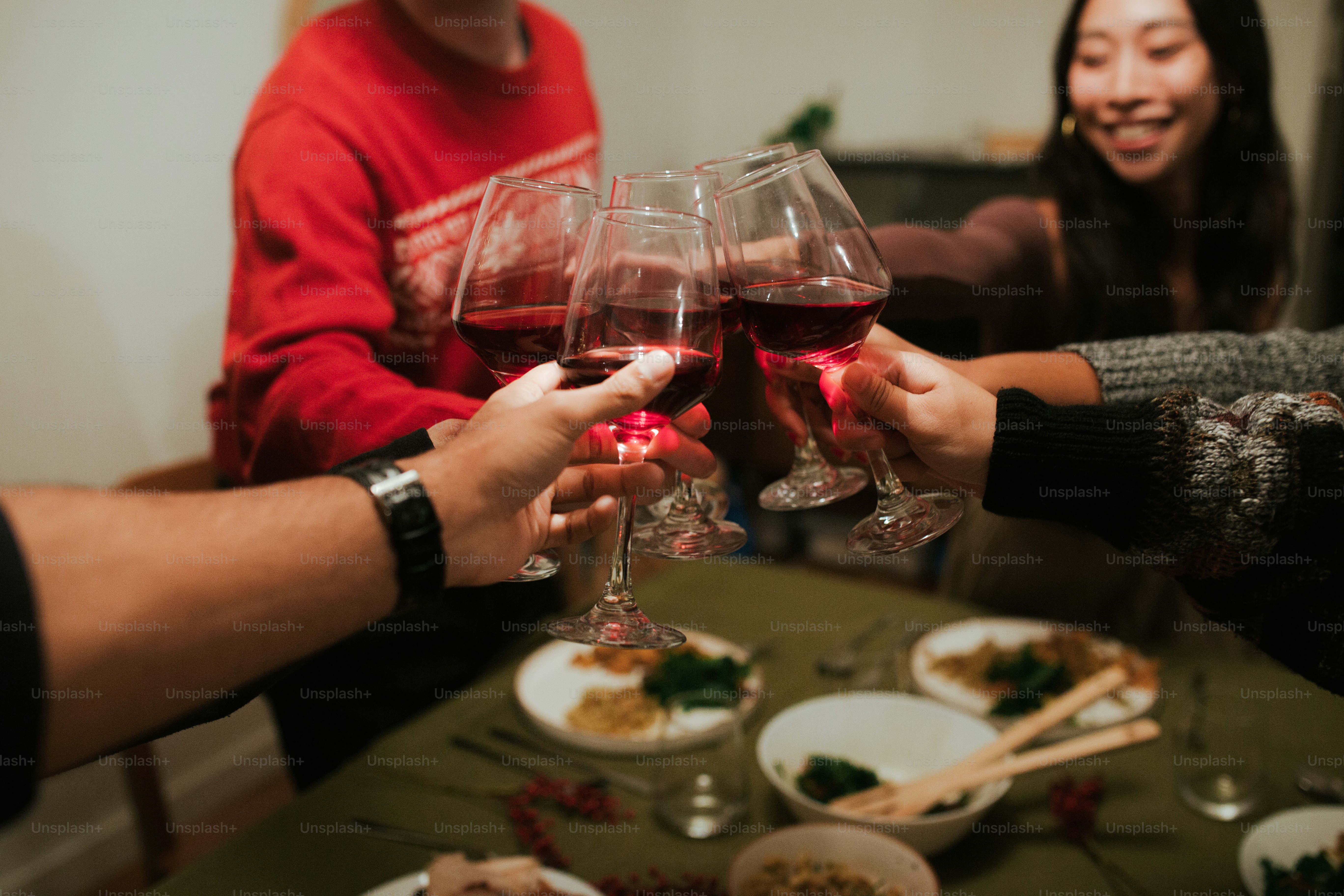 A group of people toasting with red wine photo – Thanksgiving Image on ...