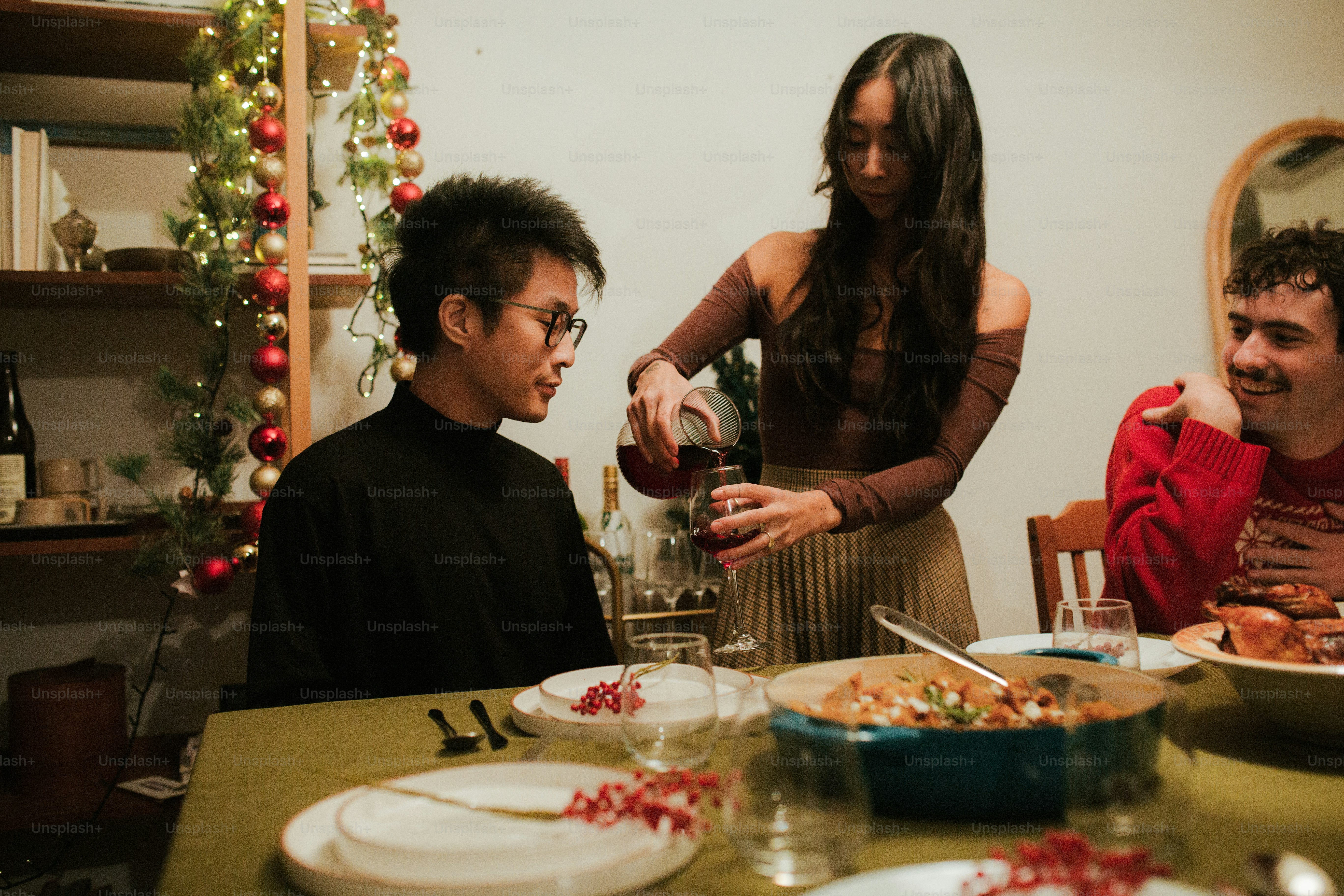 A group of people sitting around a dinner table photo – Thanksgiving ...