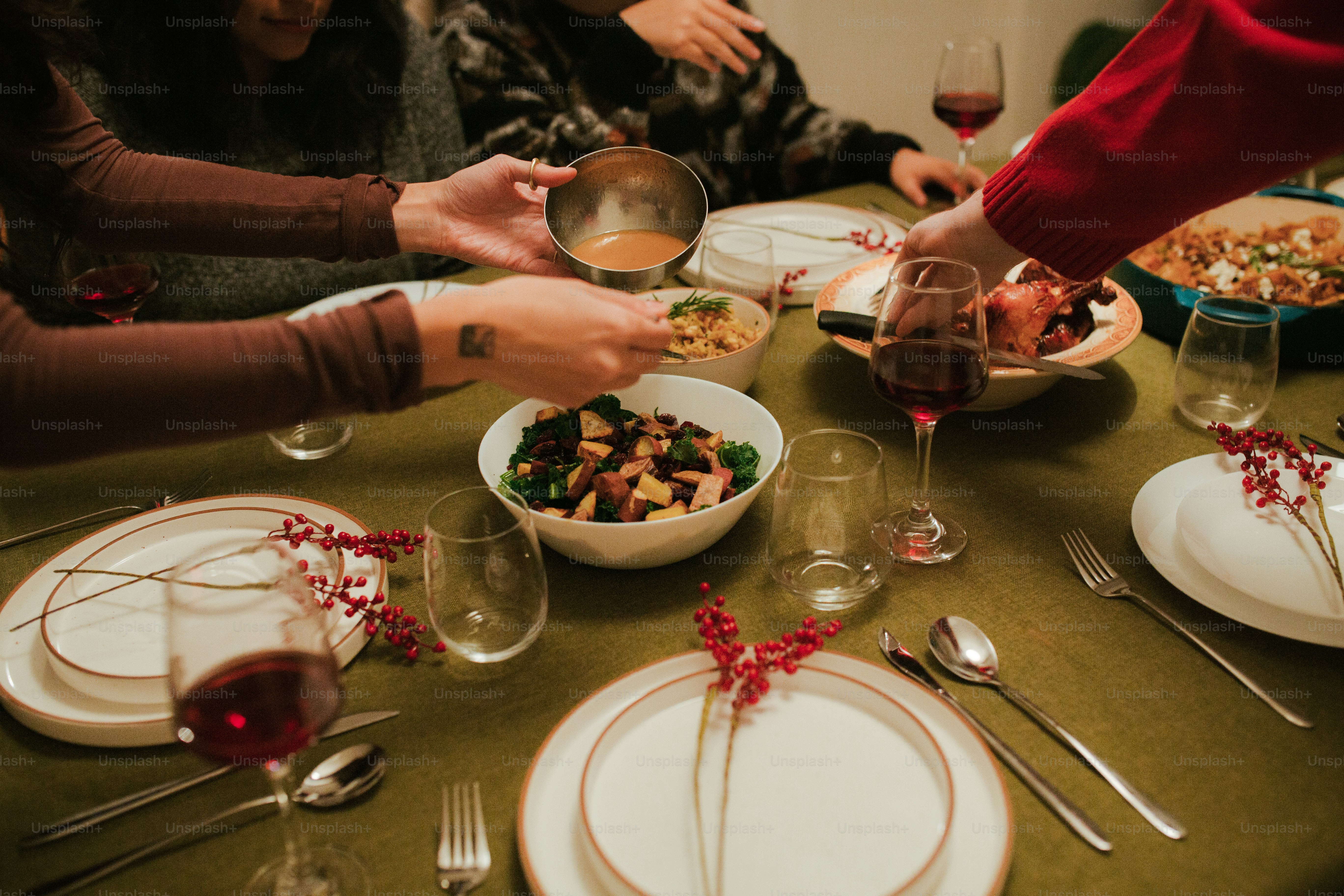 A group of people sitting around a dinner table photo – Seasonal Image ...