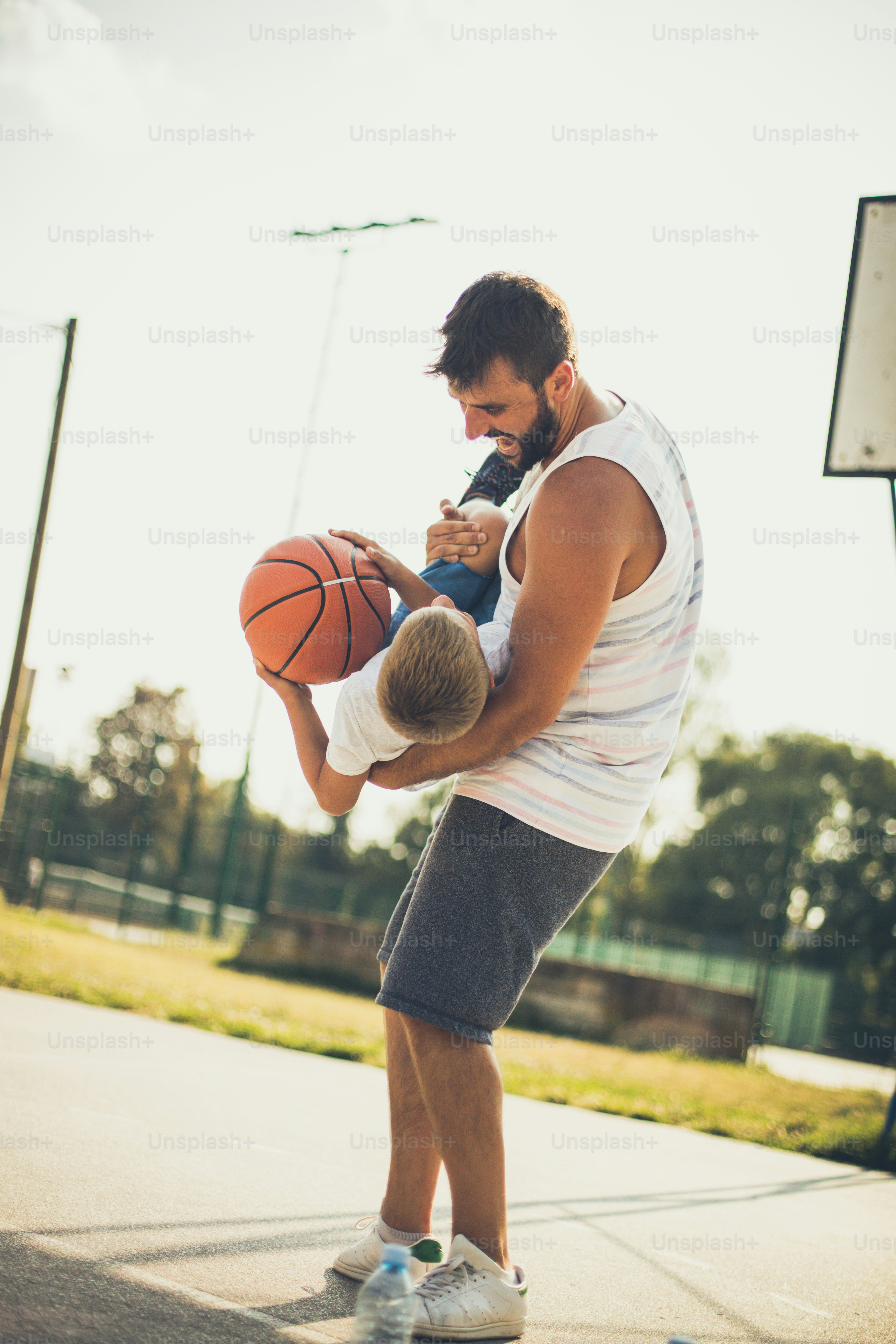 Summer day. Father and son on basket court. photo – Serbia Image on ...