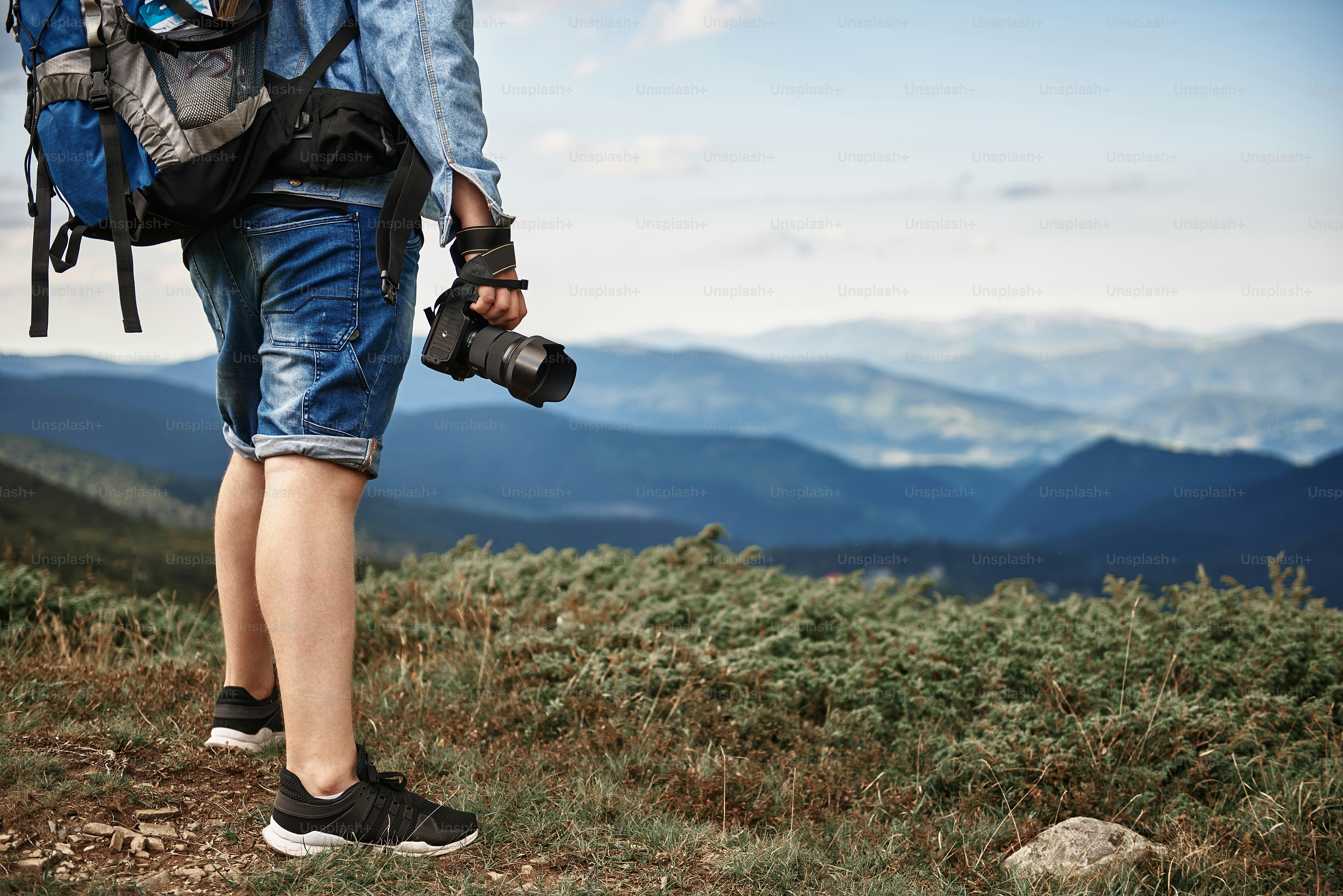 Modern camera. Professional experienced photographer holding his modern ...