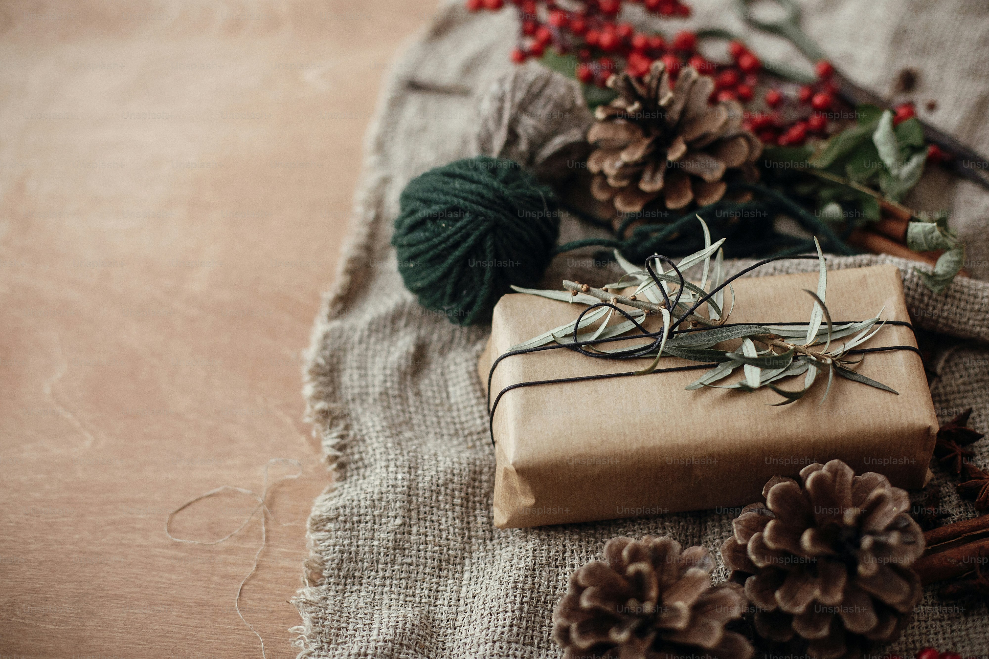 Stylish rustic christmas gift box with green branch and fir branches ...