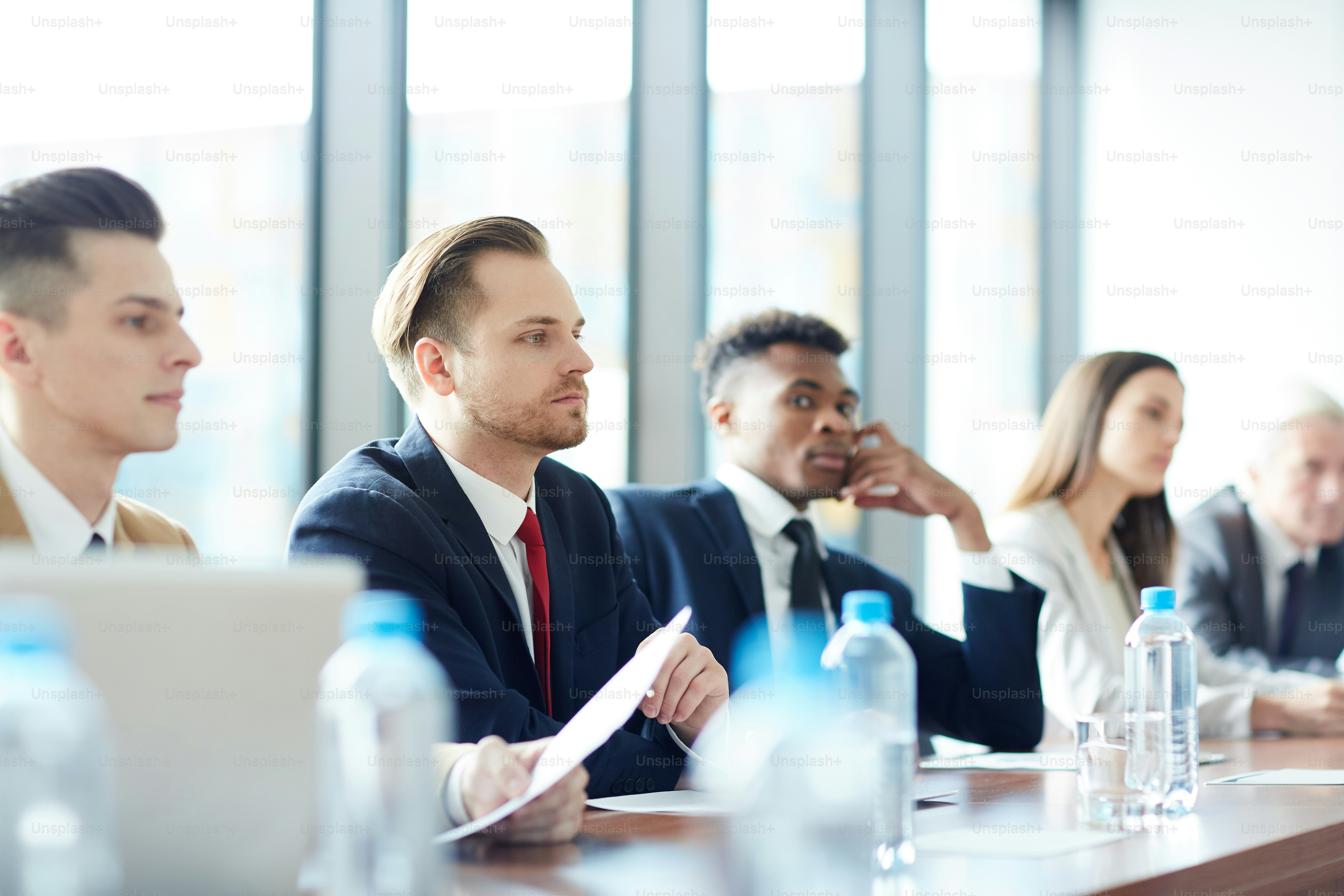 One of intercultural delegates listening to speaker at political ...